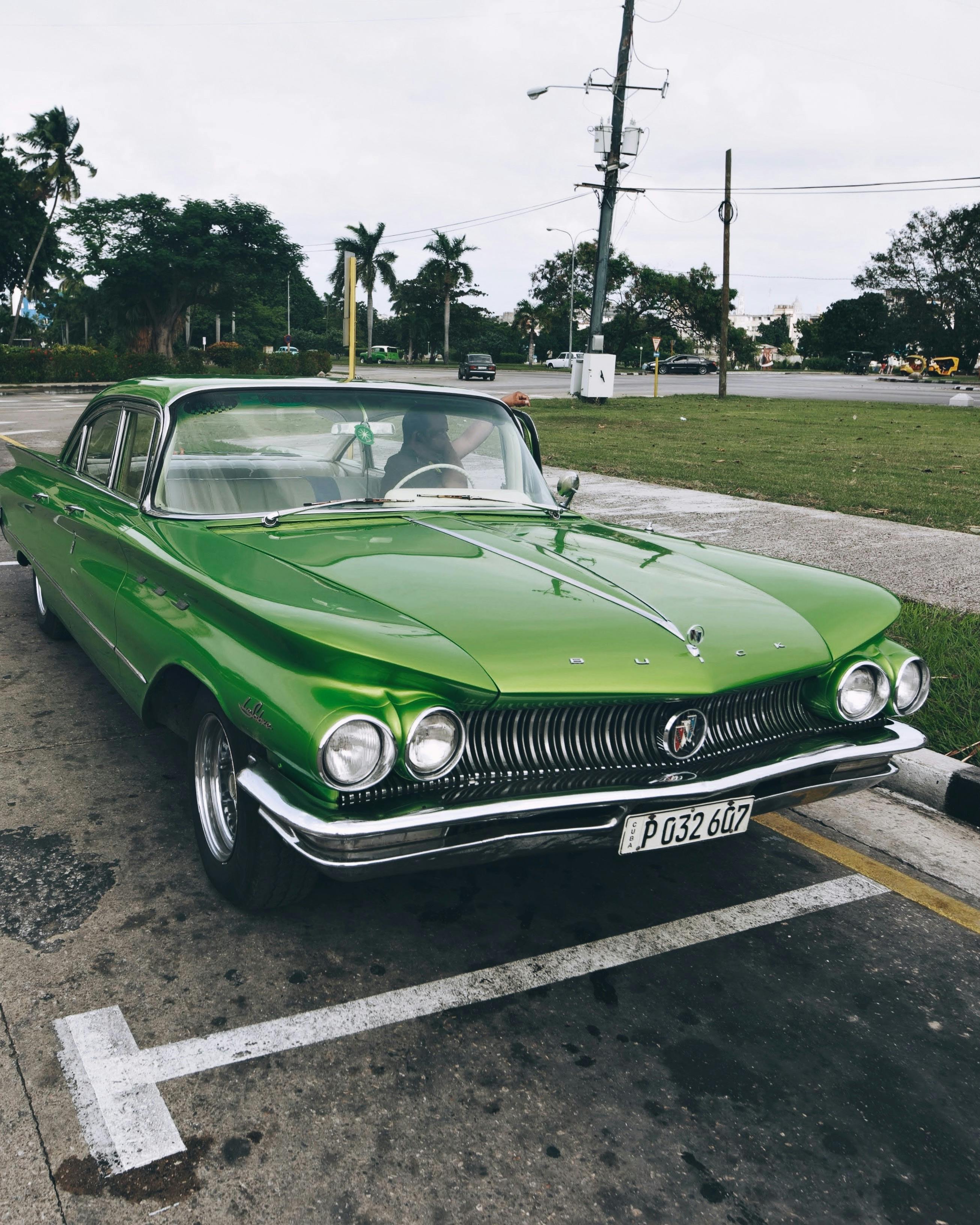 A Vintage Green Buick Invicta on a Parking Lot · Free Stock Photo