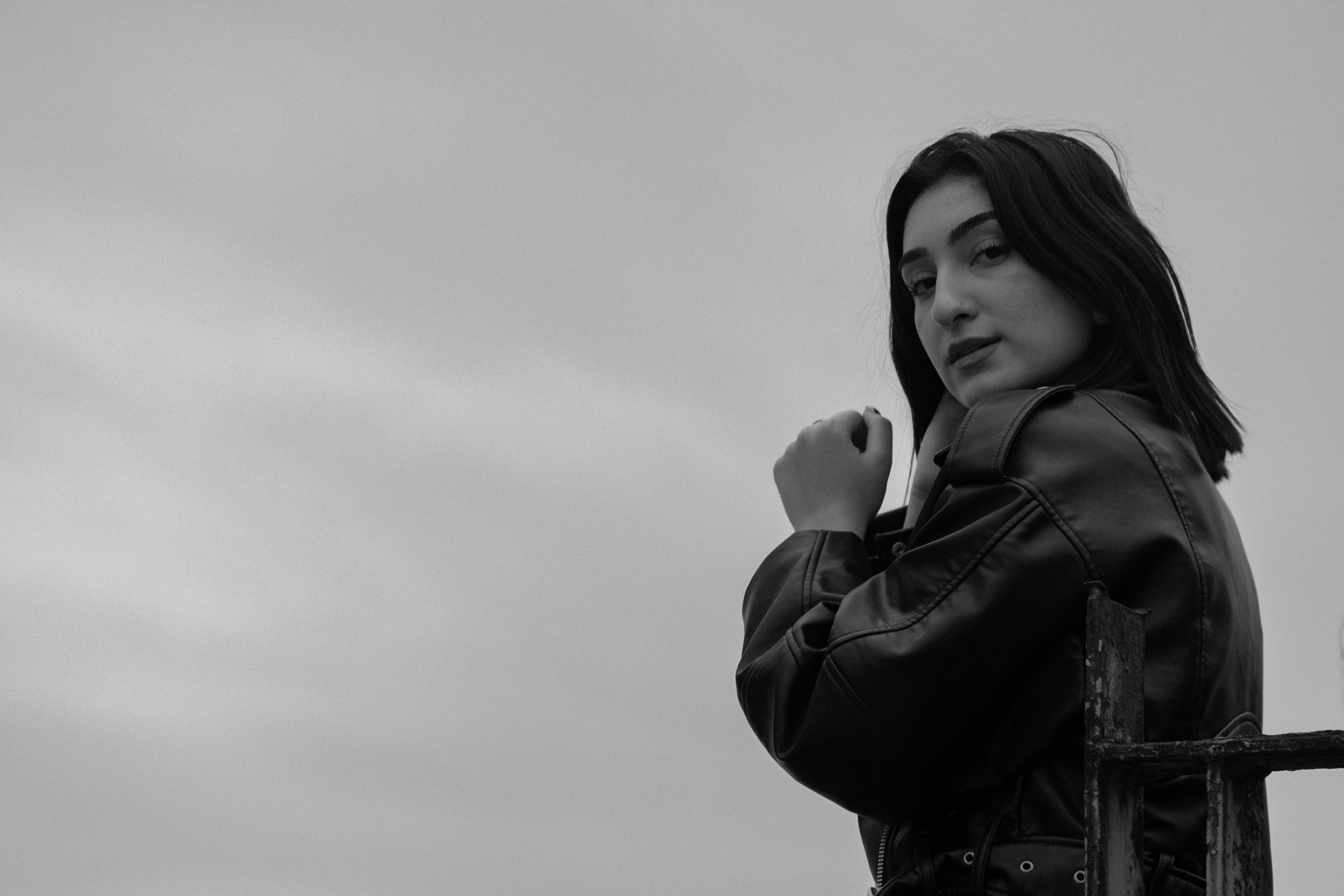 Woman in Unzipped Jacket on Grassland · Free Stock Photo
