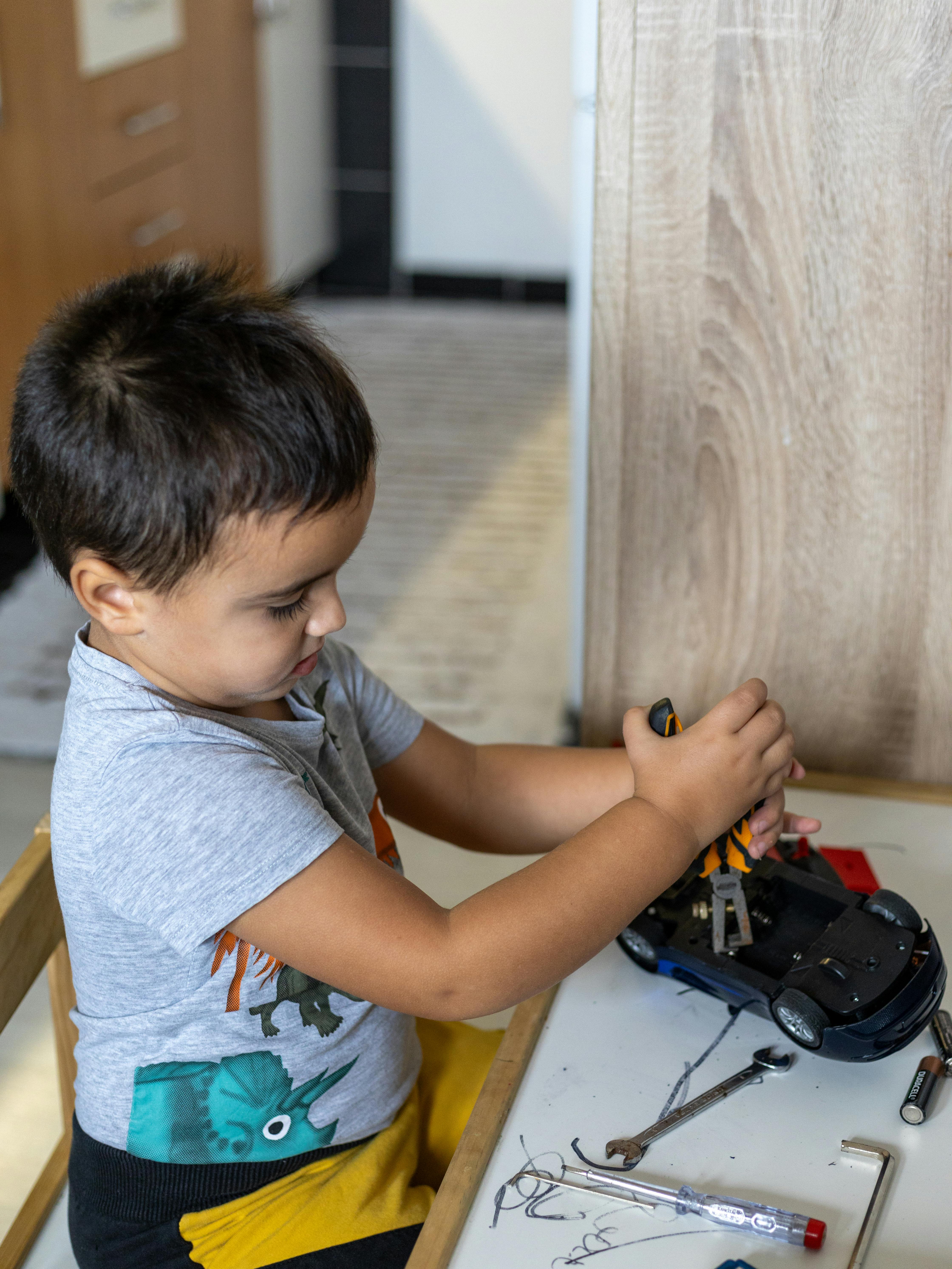 Boy Repairing Toy Car · Free Stock Photo