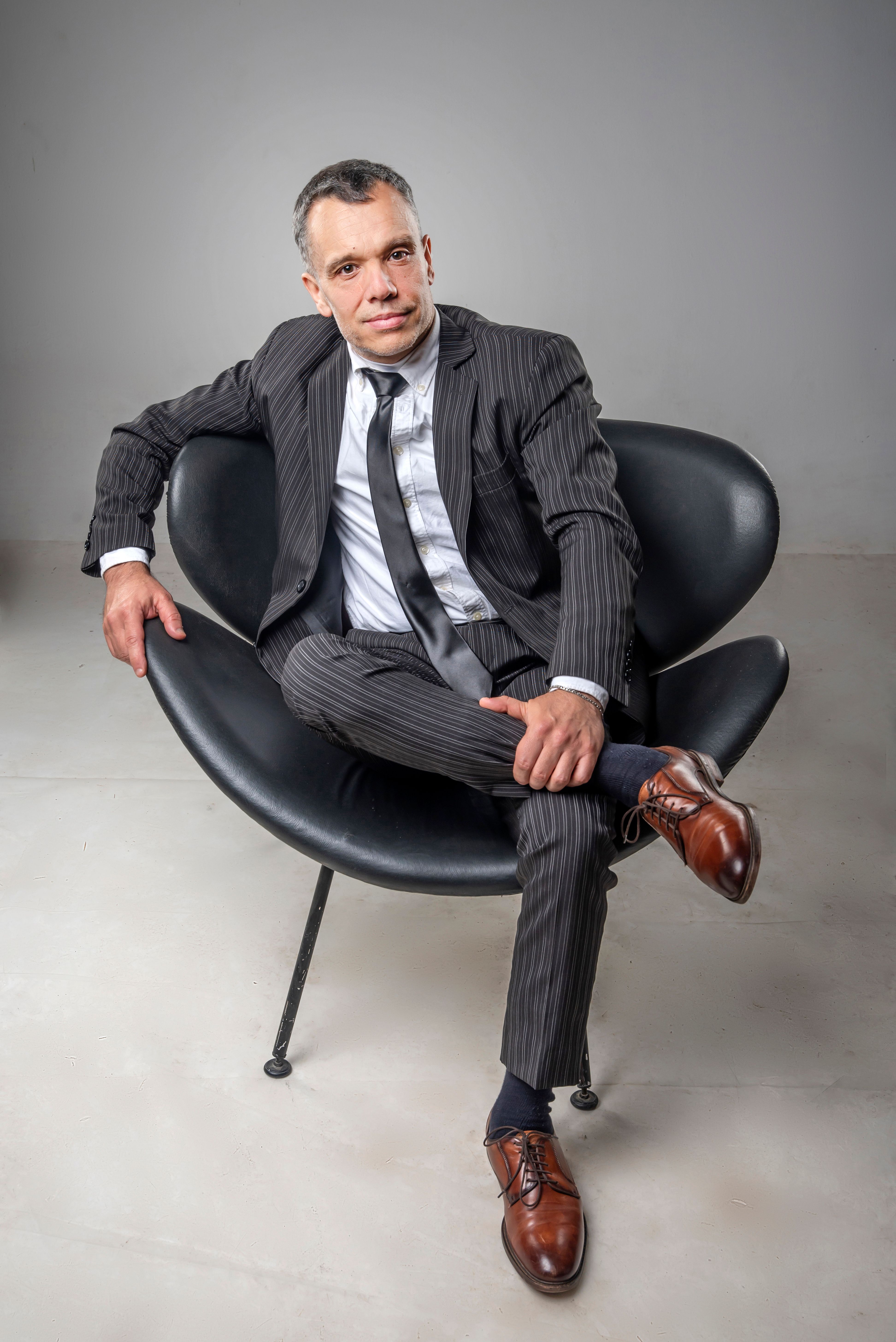 Man in Suit Sitting on Chair · Free Stock Photo