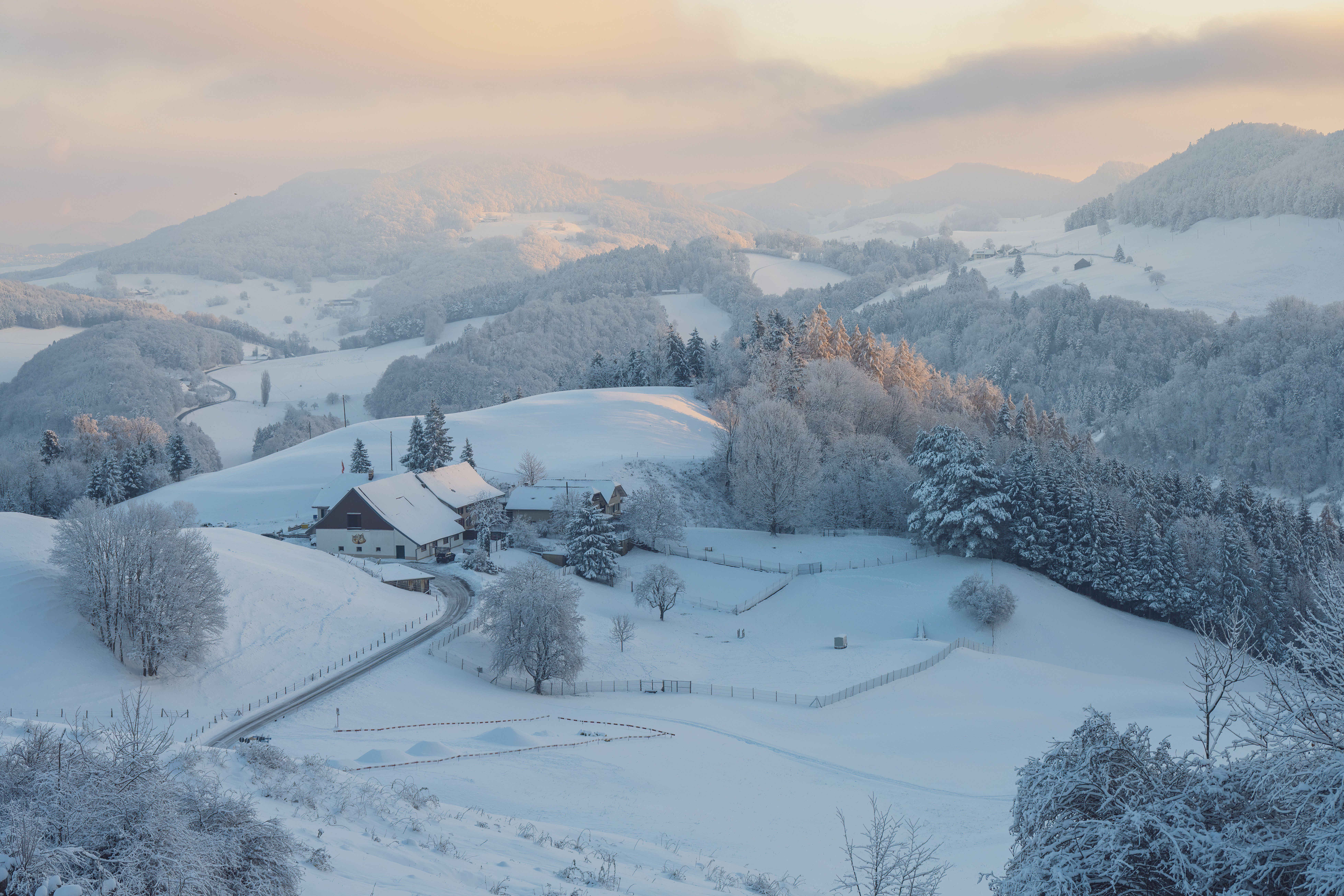 Aerial View of a Winter Landscape with Hills and Trees · Free Stock Photo