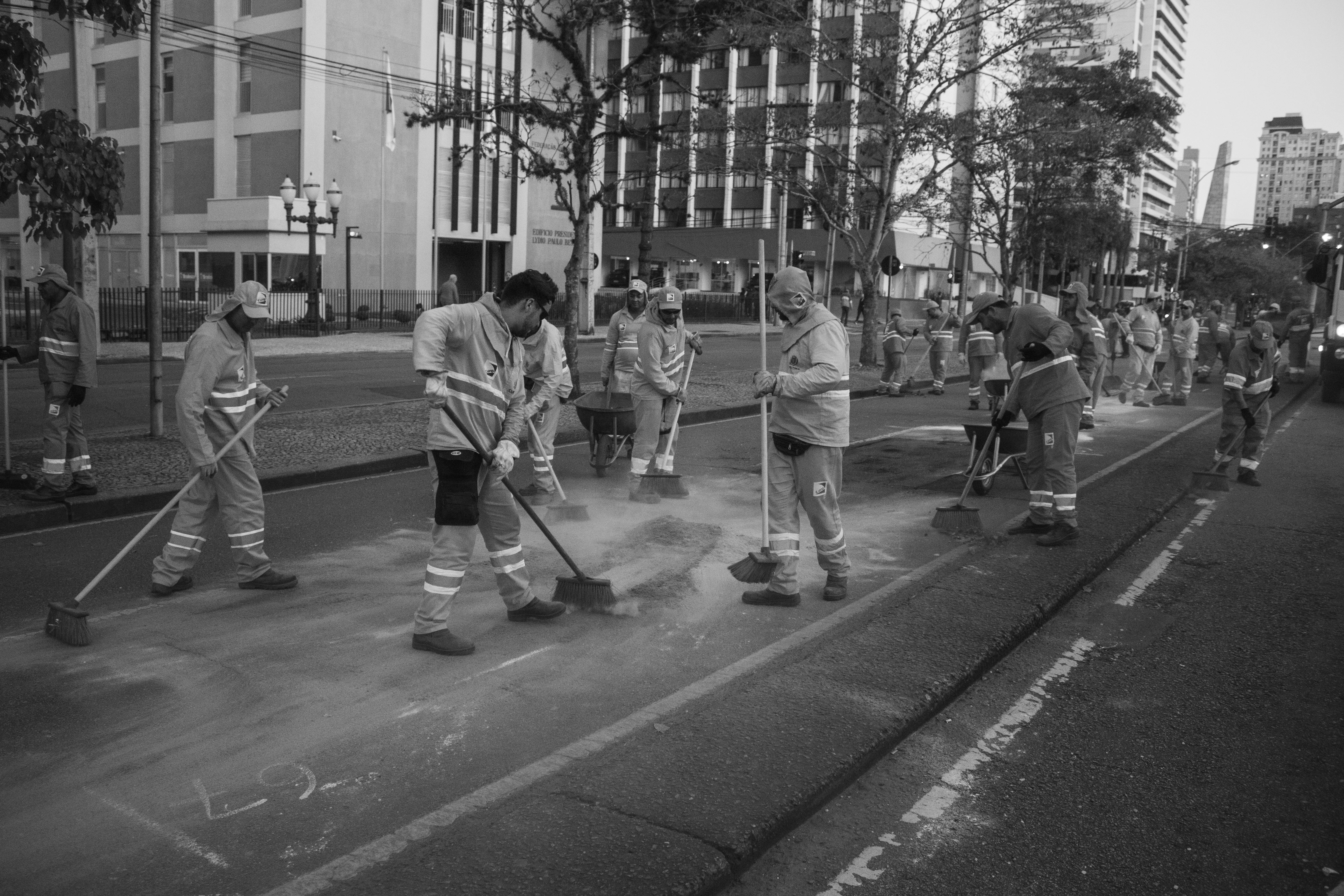 Cleaners Cleaning Sidewalk in Black and White · Free Stock Photo