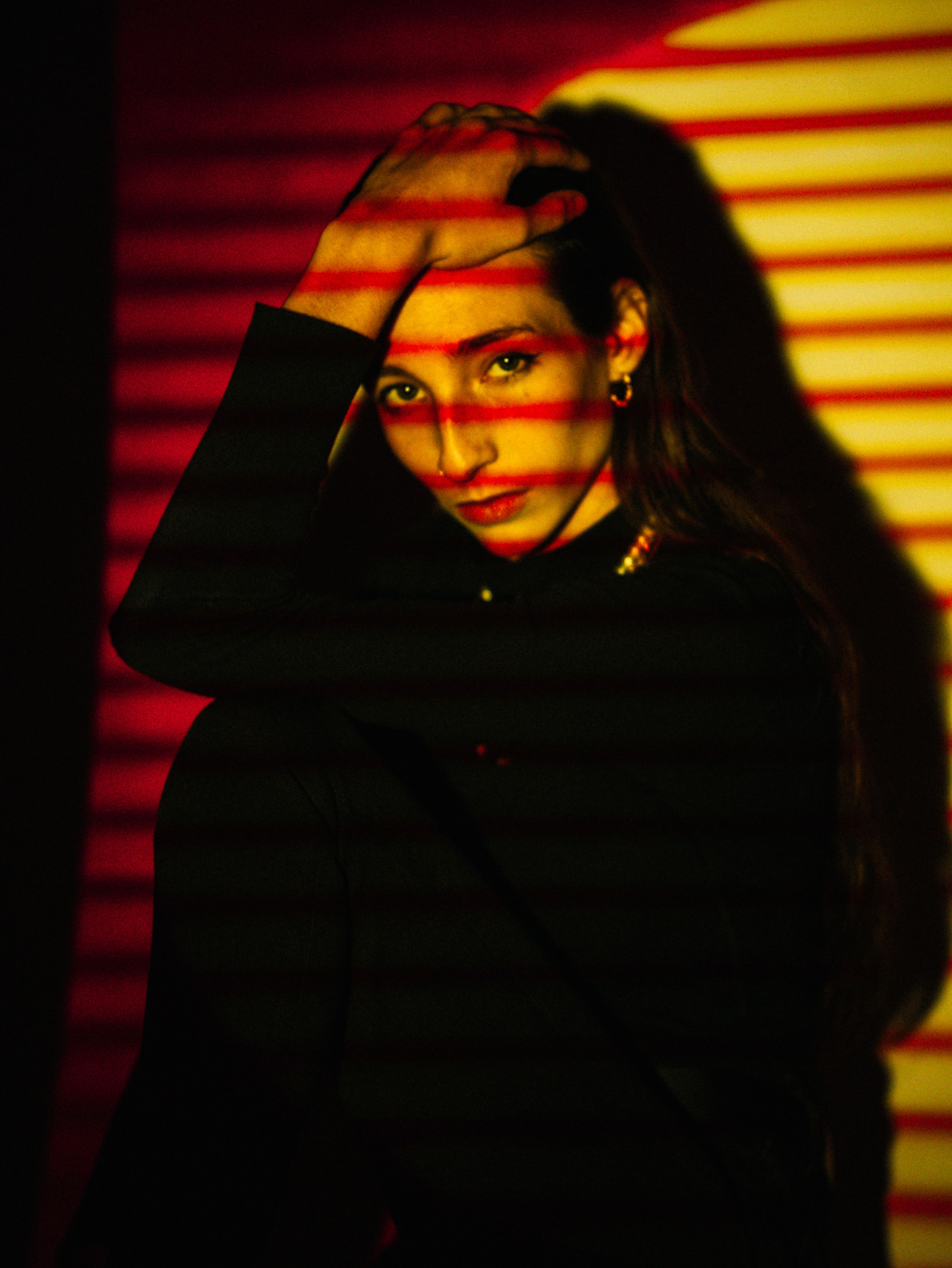 Window Blinds Casting Shadows on a Young Woman Posing by a Wall · Free ...