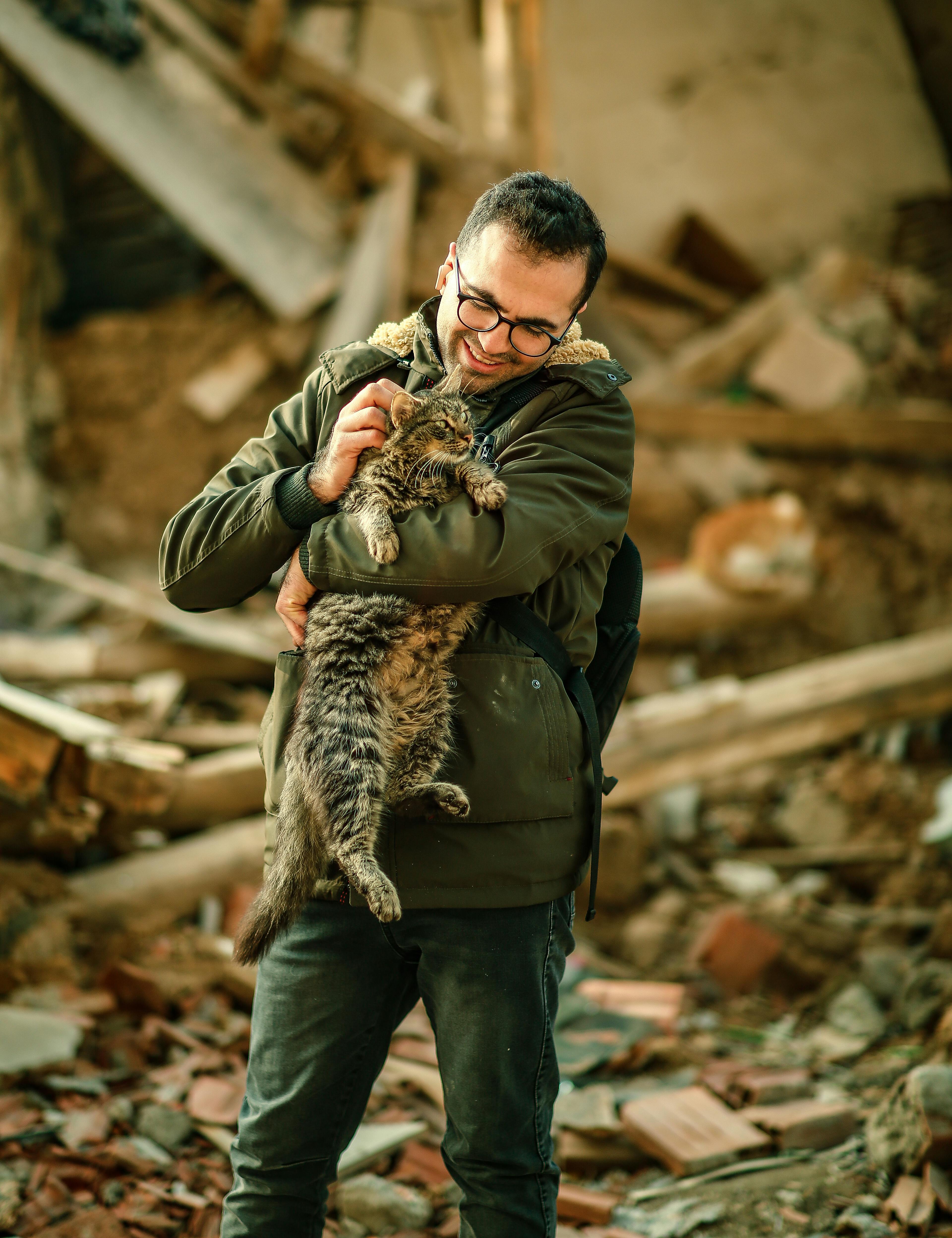 Smiling Man Holding and Patting Cat · Free Stock Photo