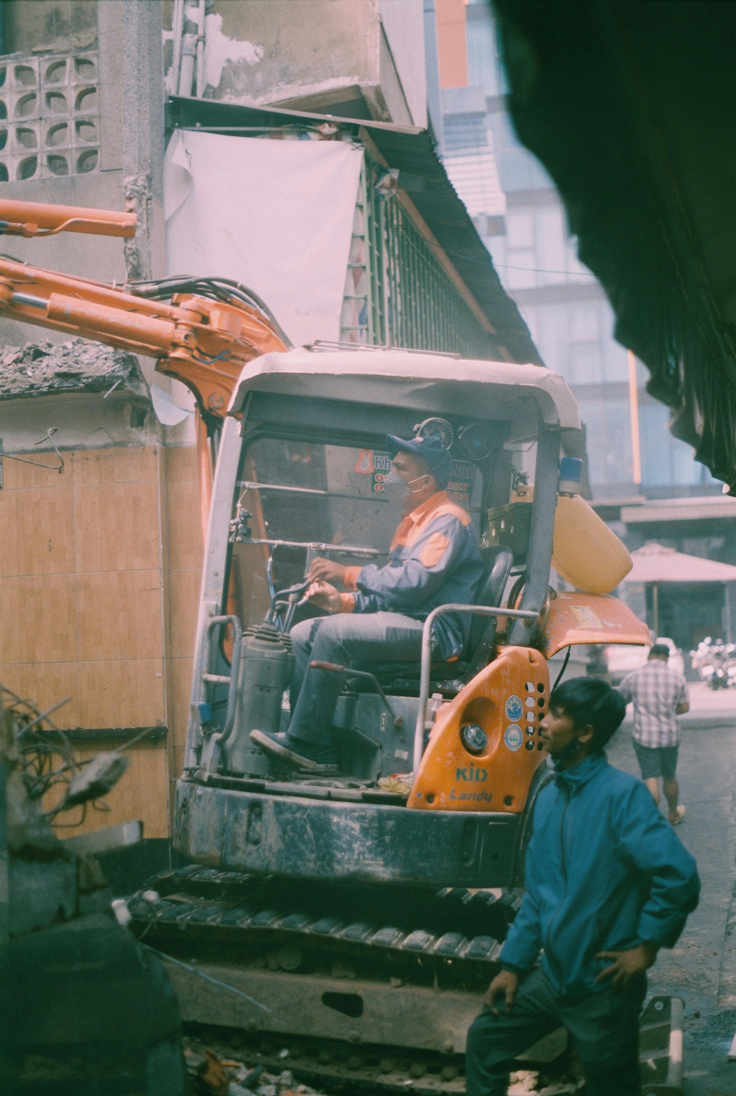 Men Operating Excavator at Construction Site · Free Stock Photo