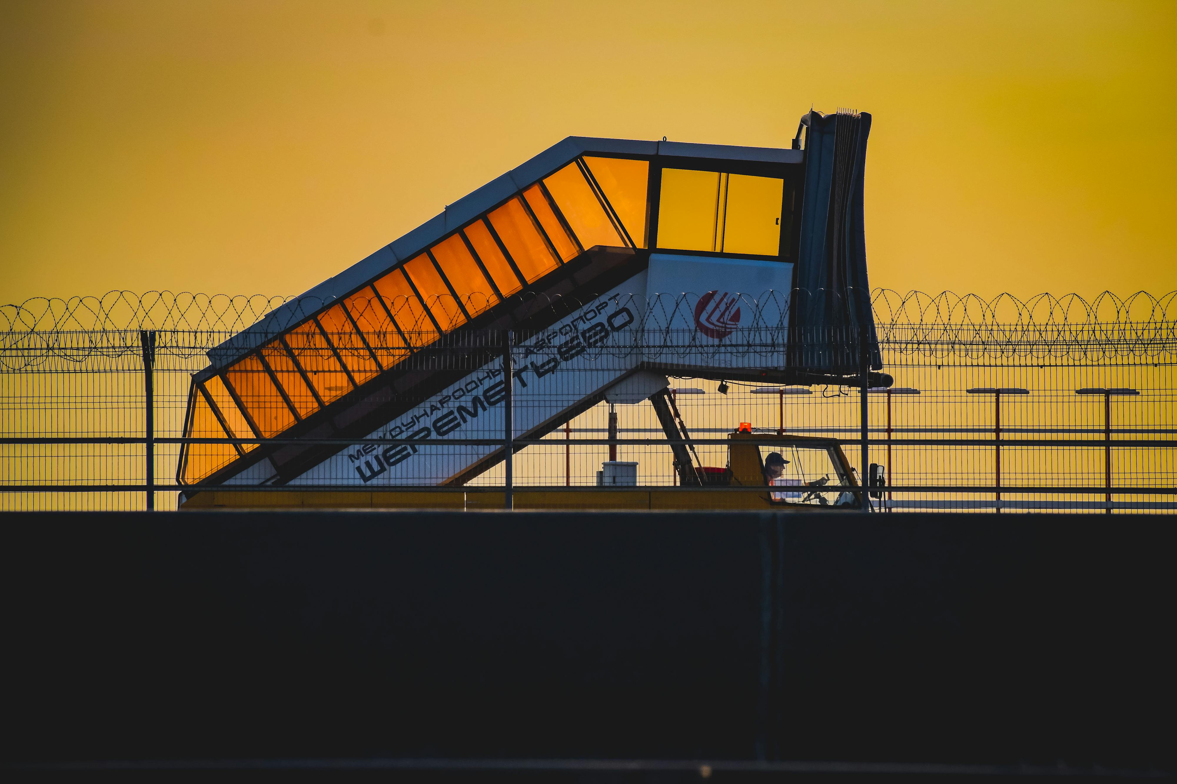 View of a Car Transporting a Jetway in the Airport · Free Stock Photo