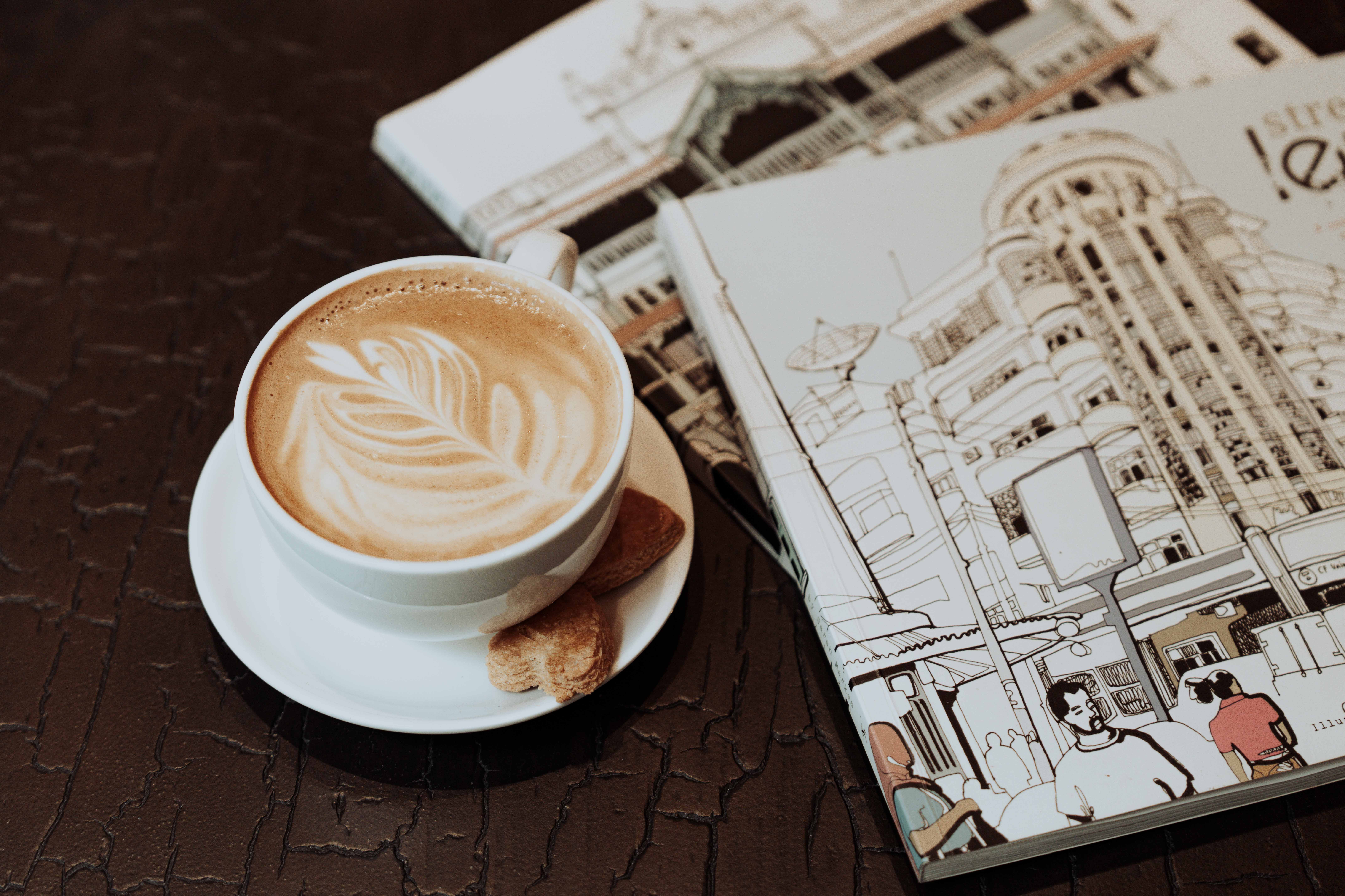 Cup of Coffee Decorated with Latte Art with Cookies on a Saucer Next to ...