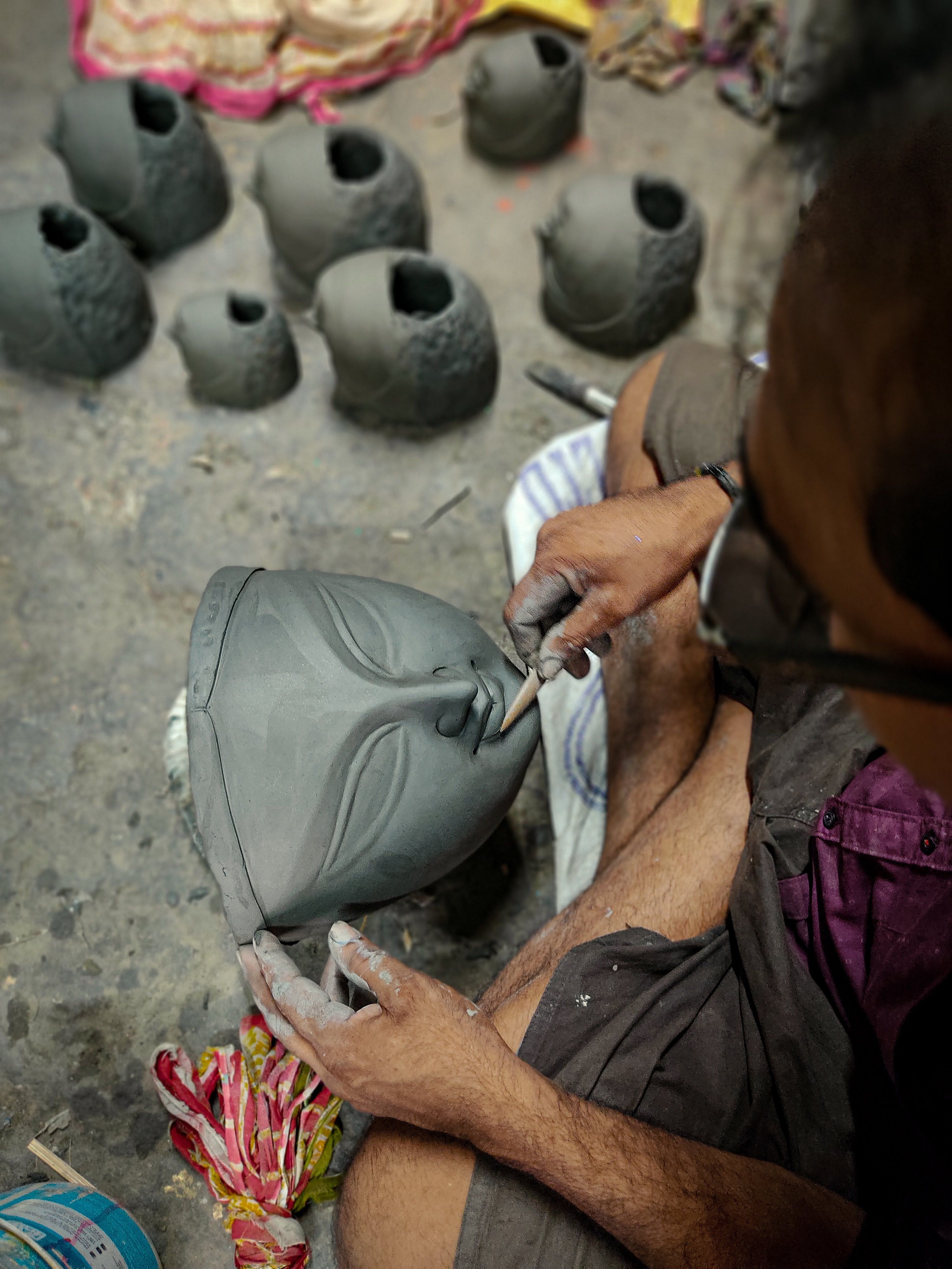 Sculptor Working on a Face in Clay · Free Stock Photo
