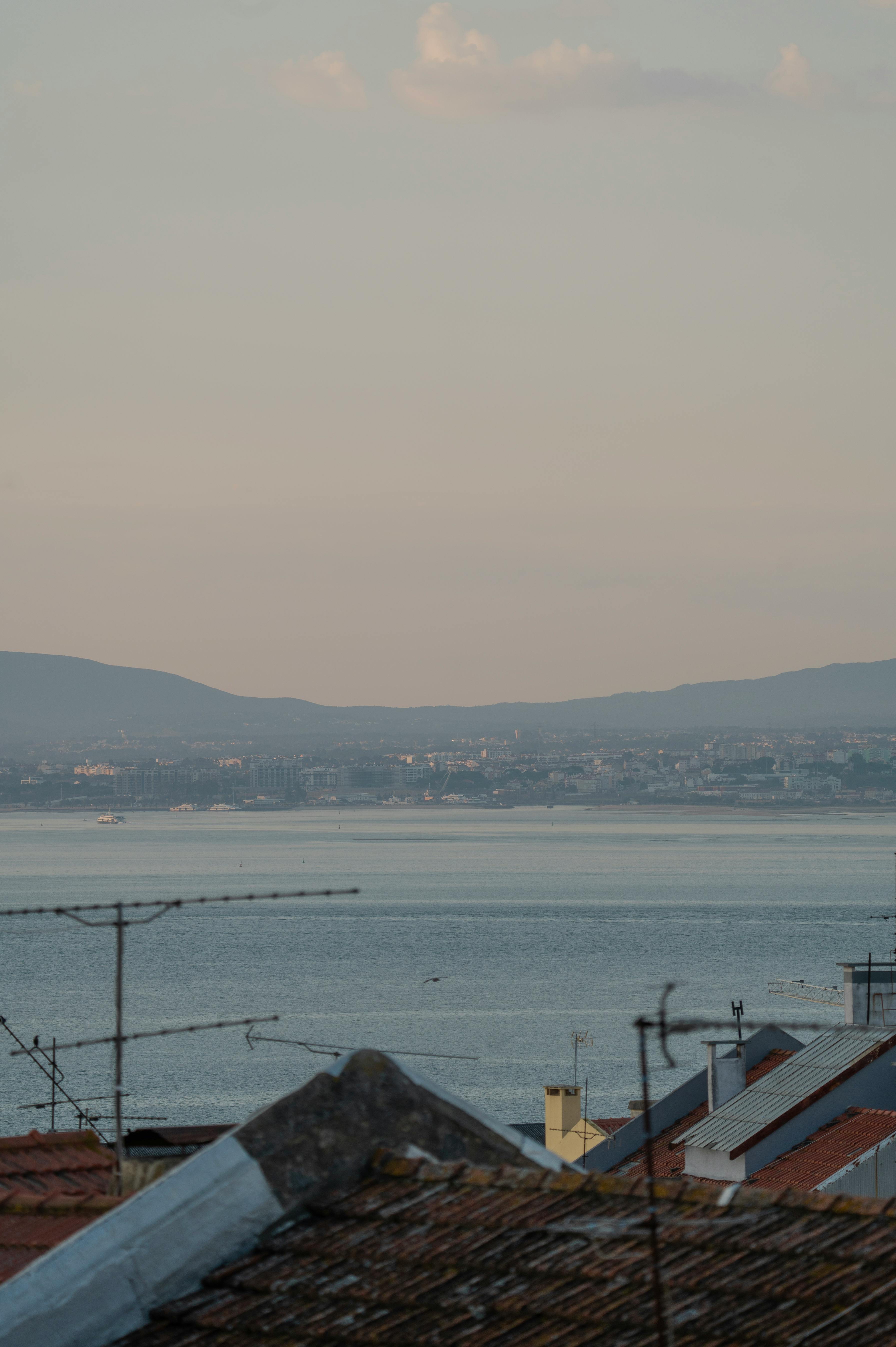 Sea View above Town Rooftops · Free Stock Photo