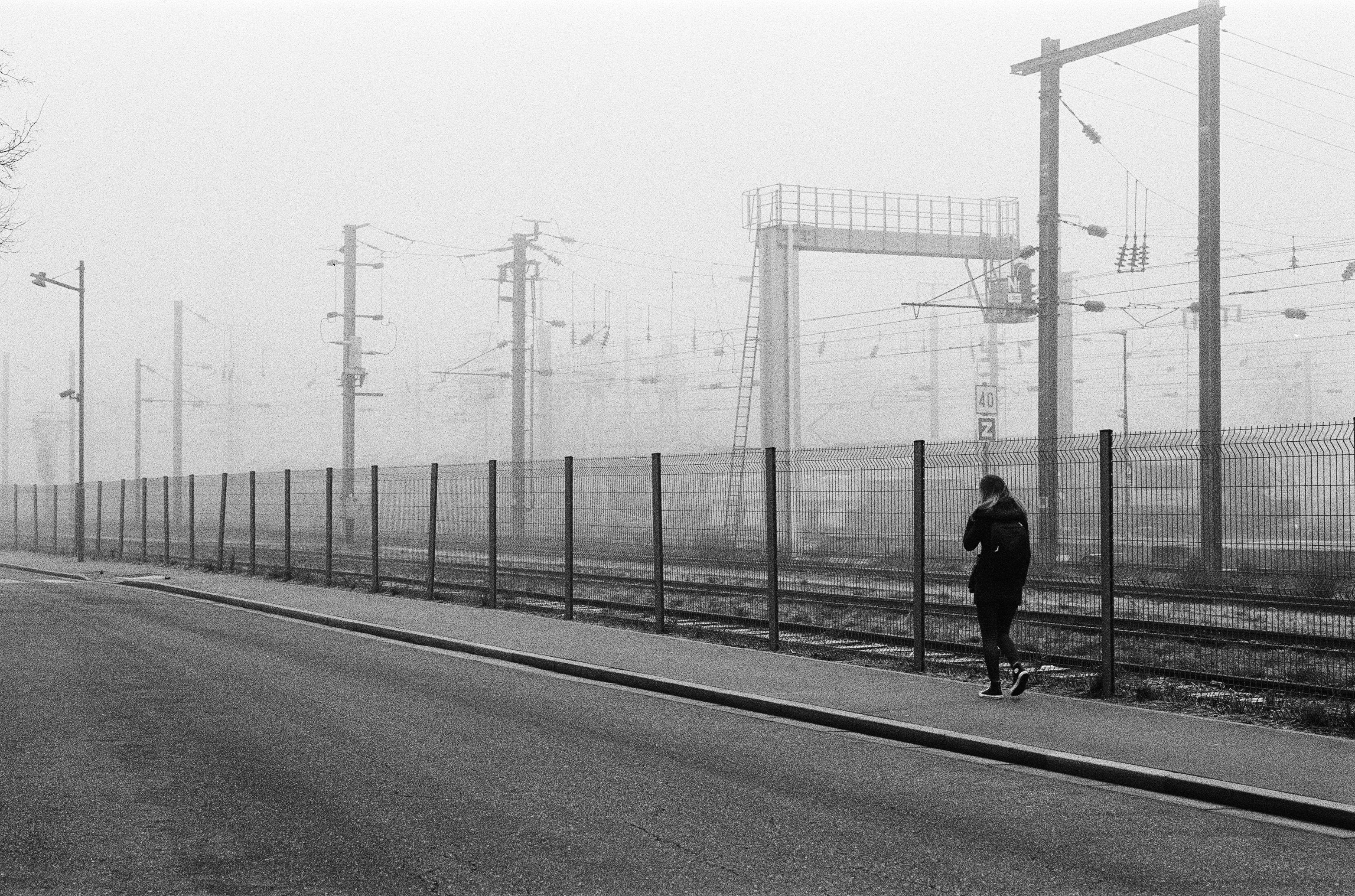 Candid Photo of a Woman Walking on the Pavement along the Railway ...