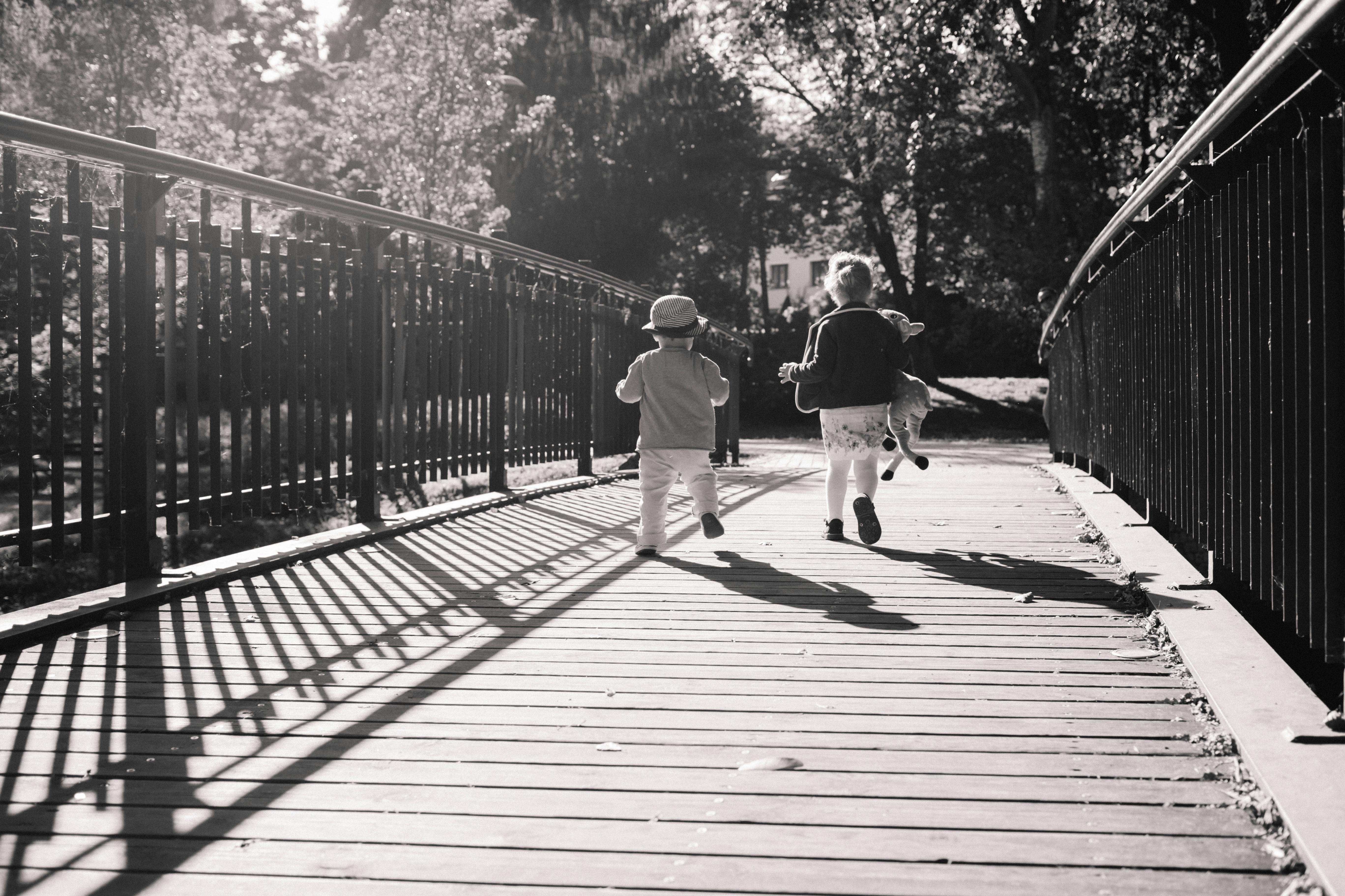 Children Running Together on Wooden Path Way Bridge · Free Stock Photo