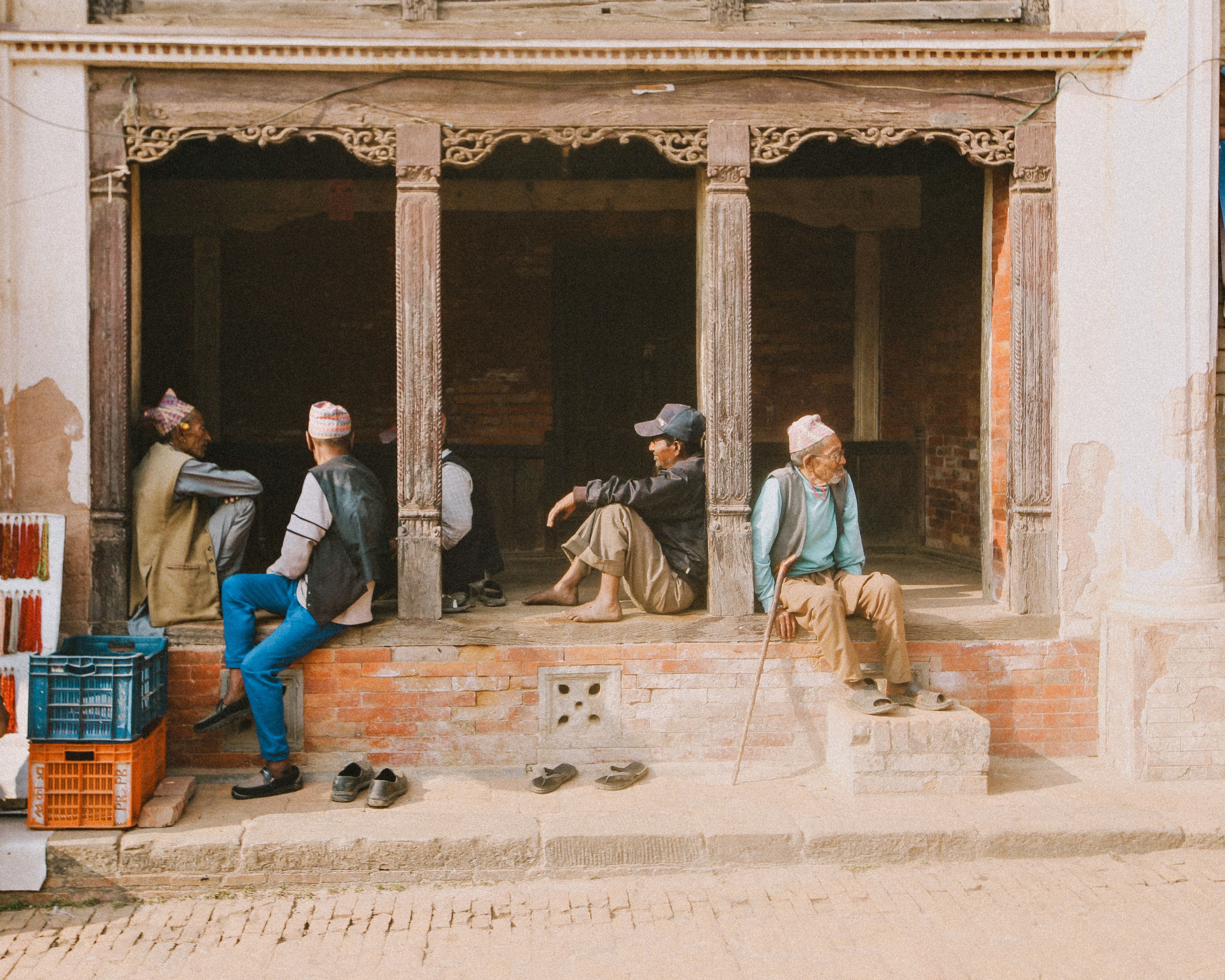 People sitting on the steps of a building · Free Stock Photo