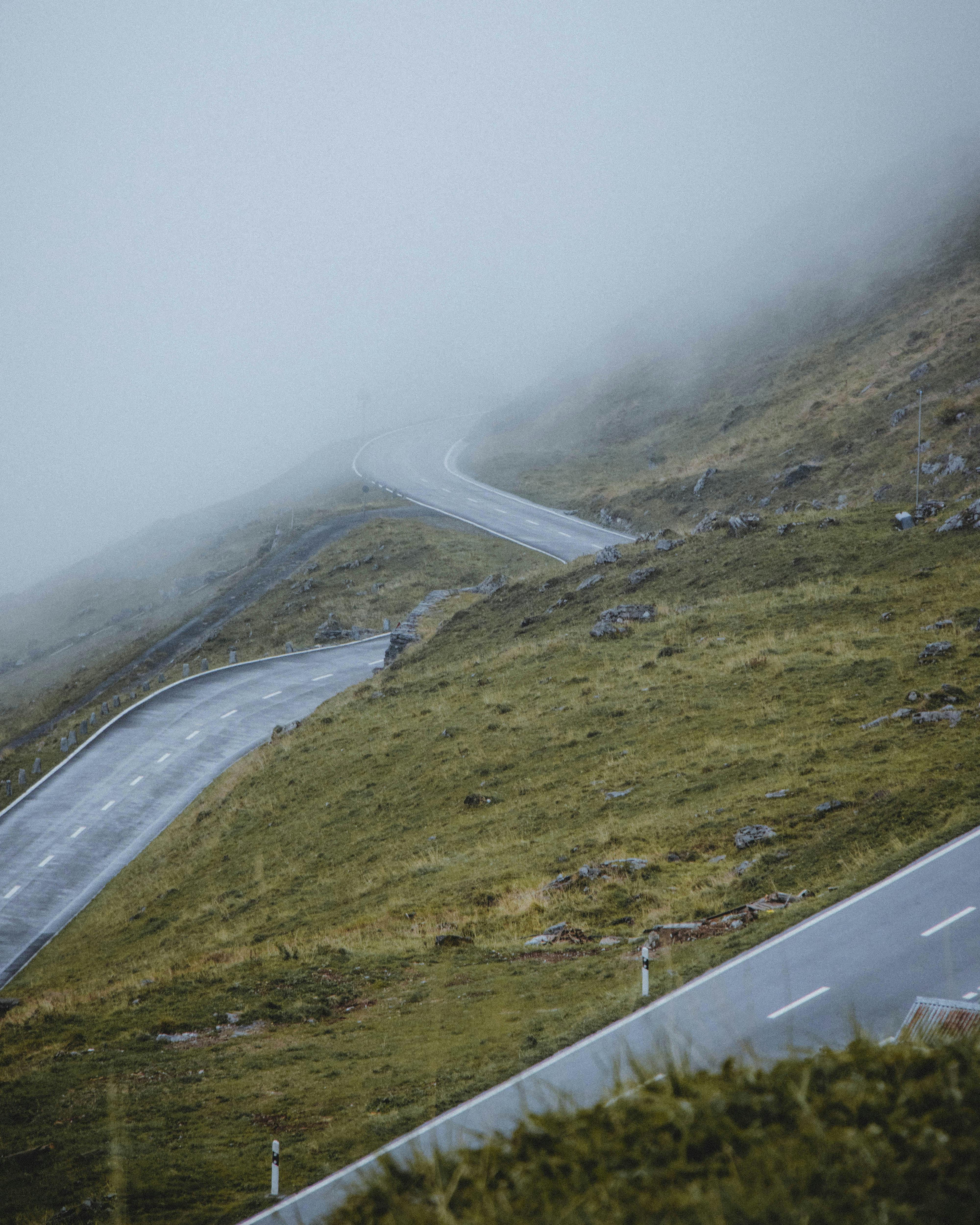 Aerial Shot of a Winding Highway Covered by Fog · Free Stock Photo