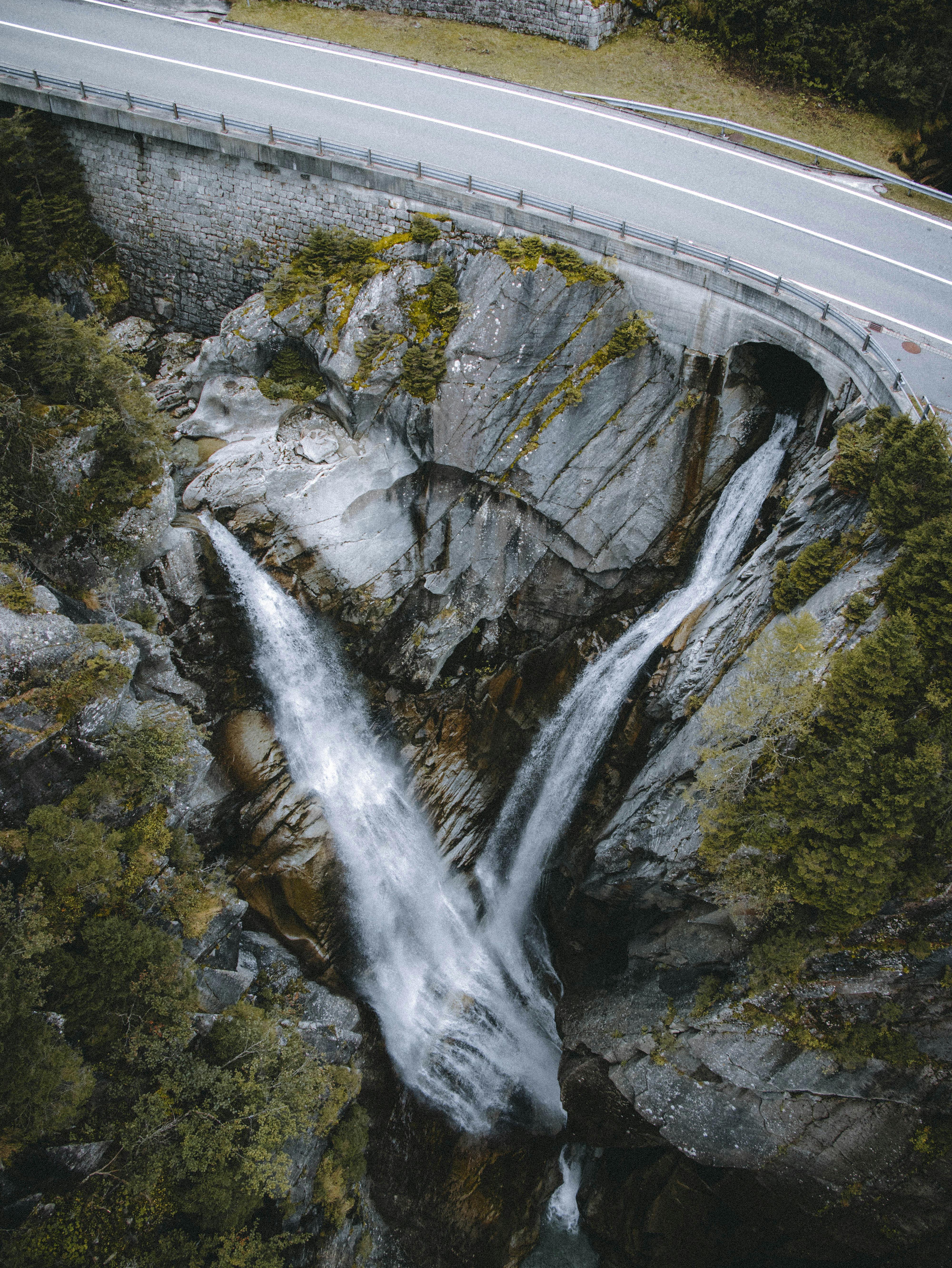 Top View of a Large Rocky Waterfall by the Road · Free Stock Photo