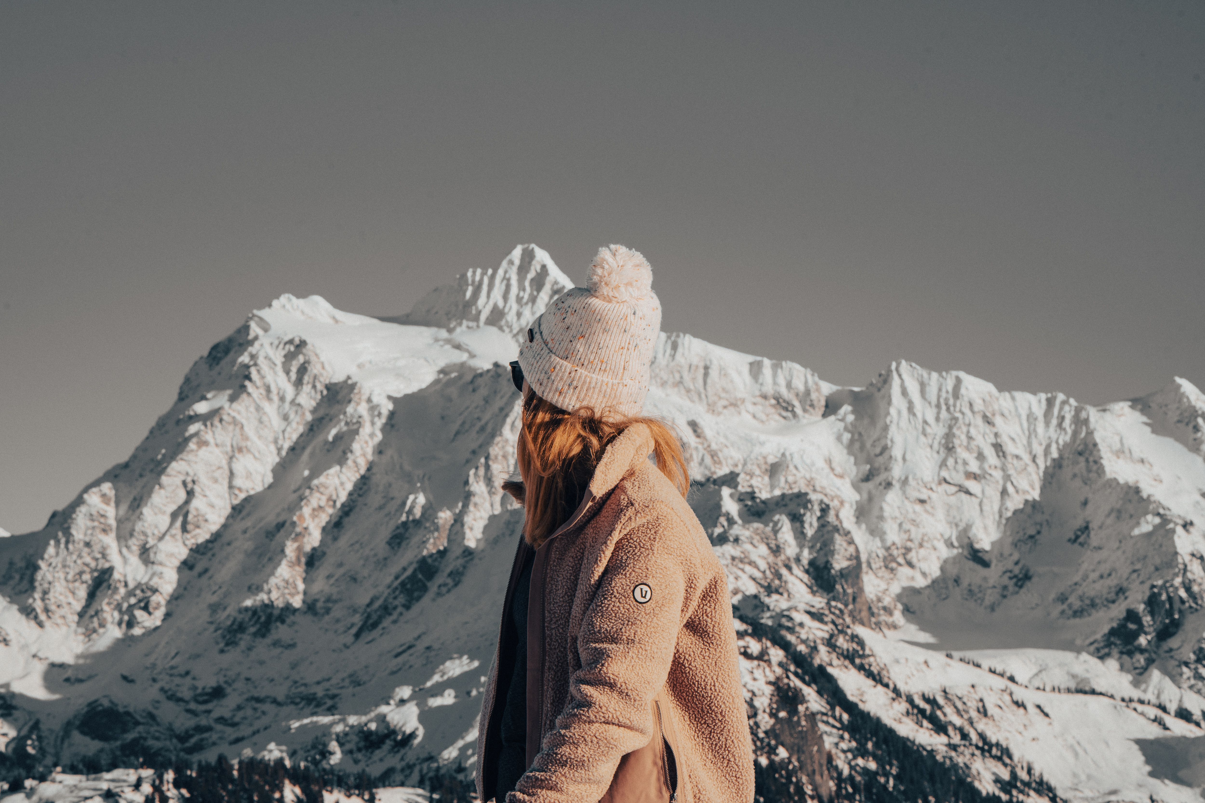 Woman Looking Behind Her at the Snow Covered Steep Mountains · Free ...