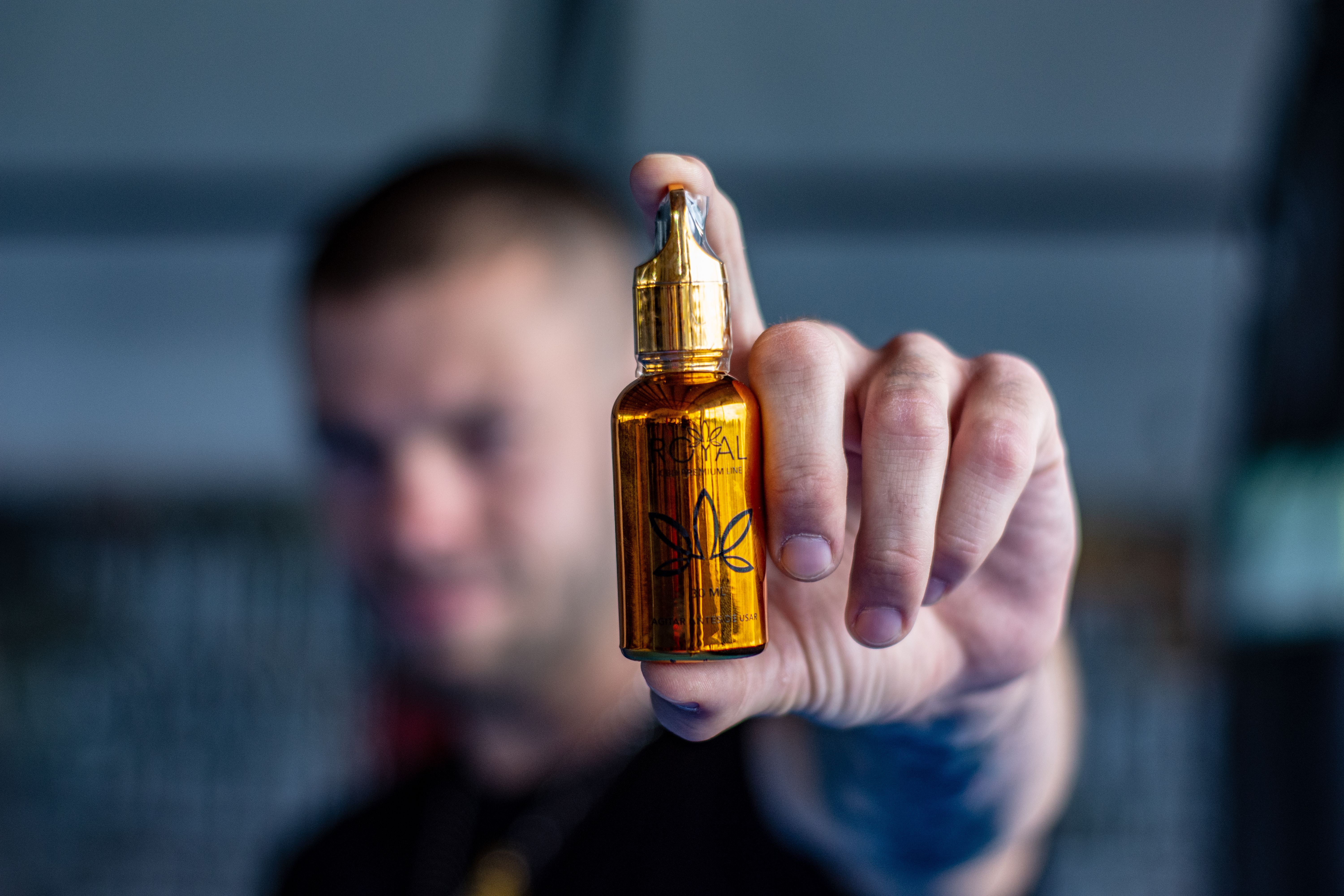 Bottle of Hemp Oil in Hand · Free Stock Photo
