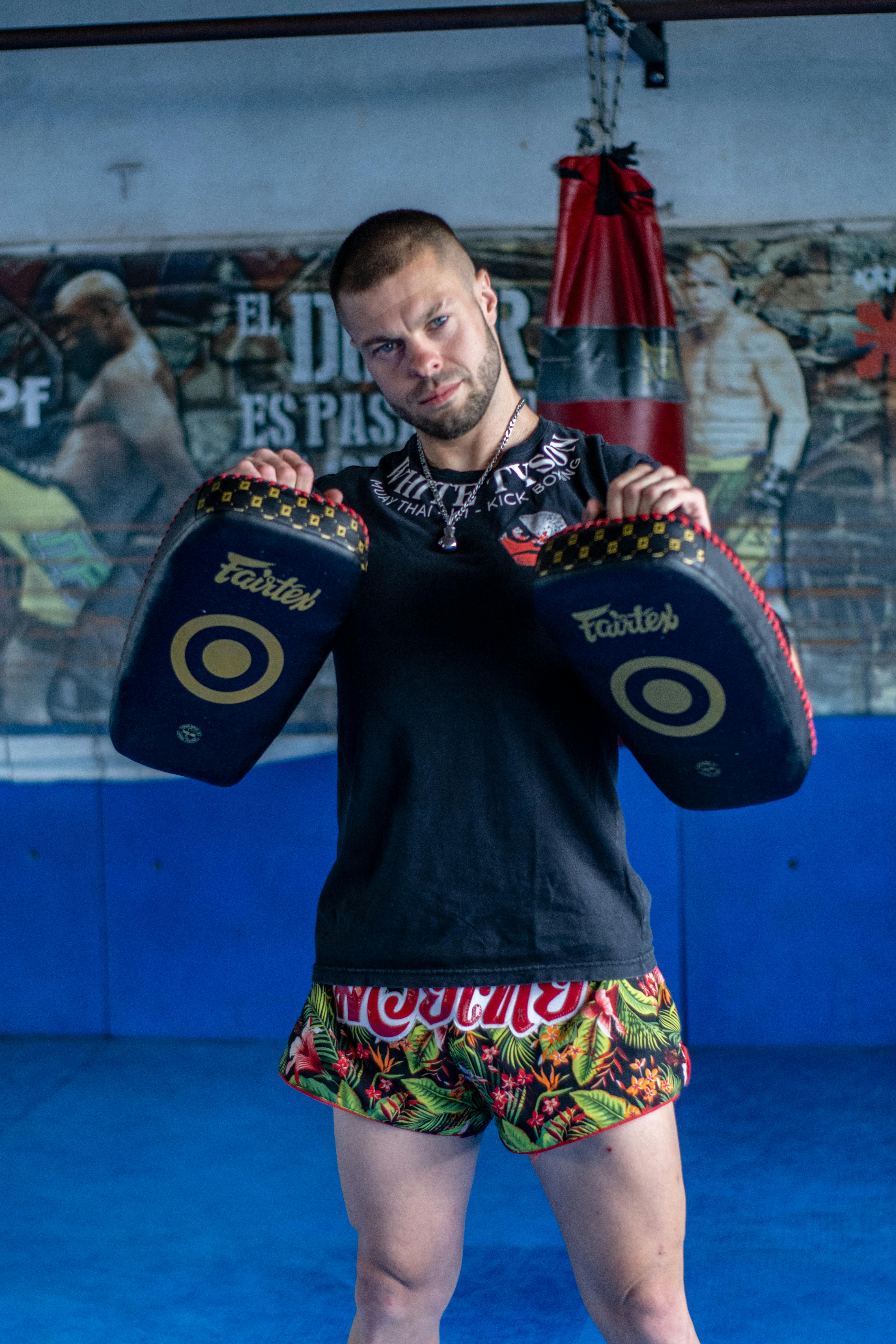 A Man Holding Training Shields · Free Stock Photo
