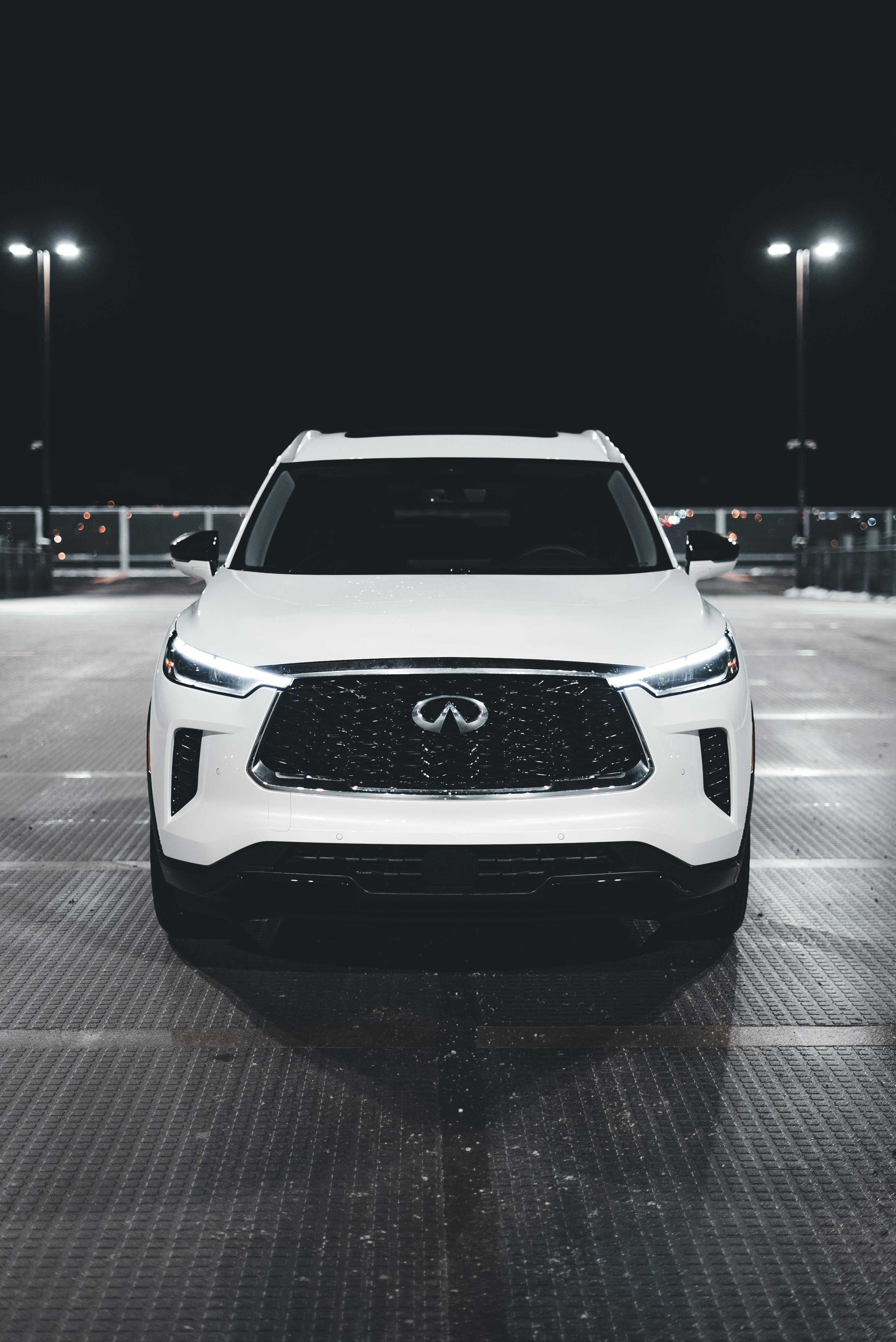 Infiniti QX60 Parked on Rooftop at Night · Free Stock Photo