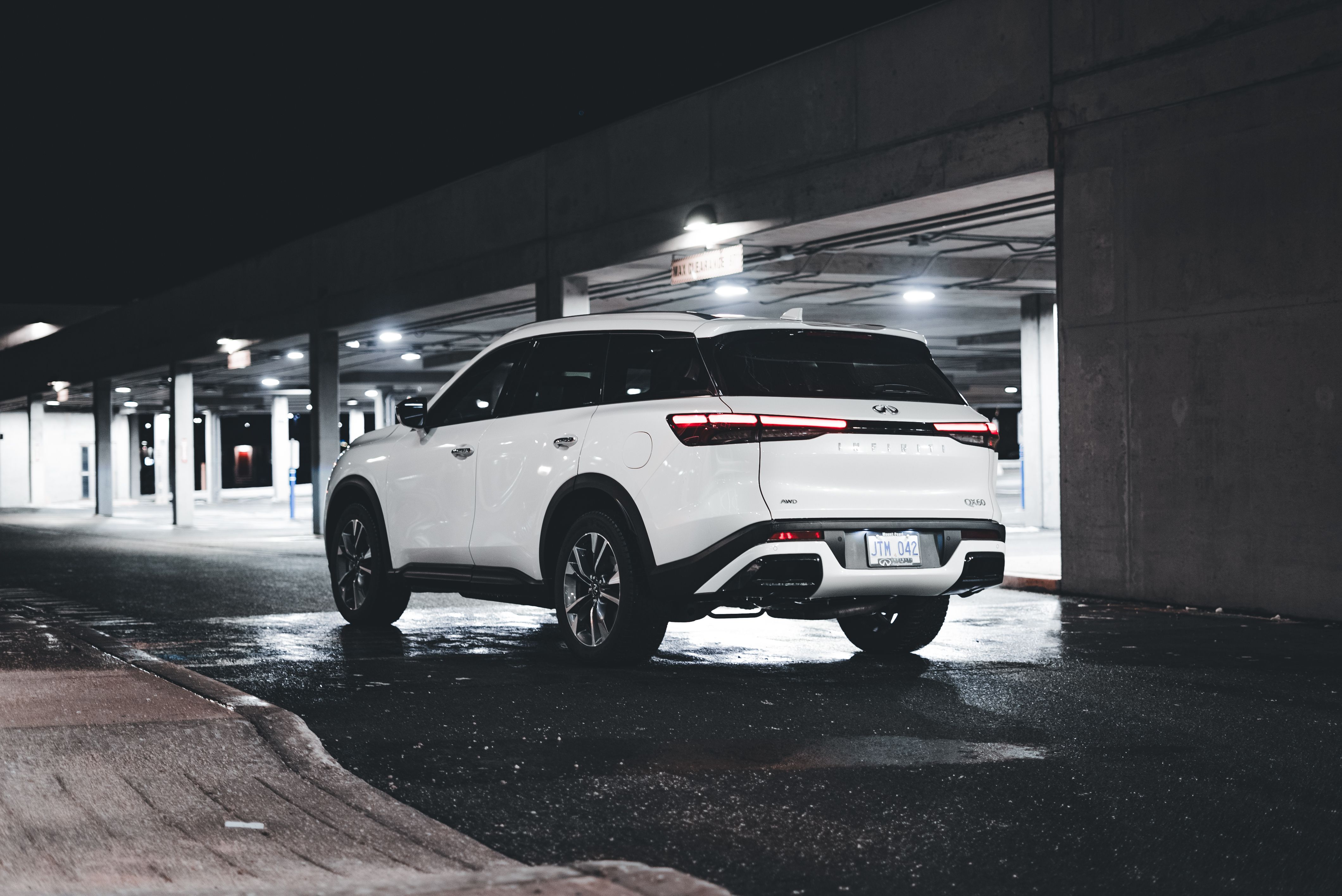 White Infiniti QX60 SUV Parked by the Parking Garage · Free Stock Photo