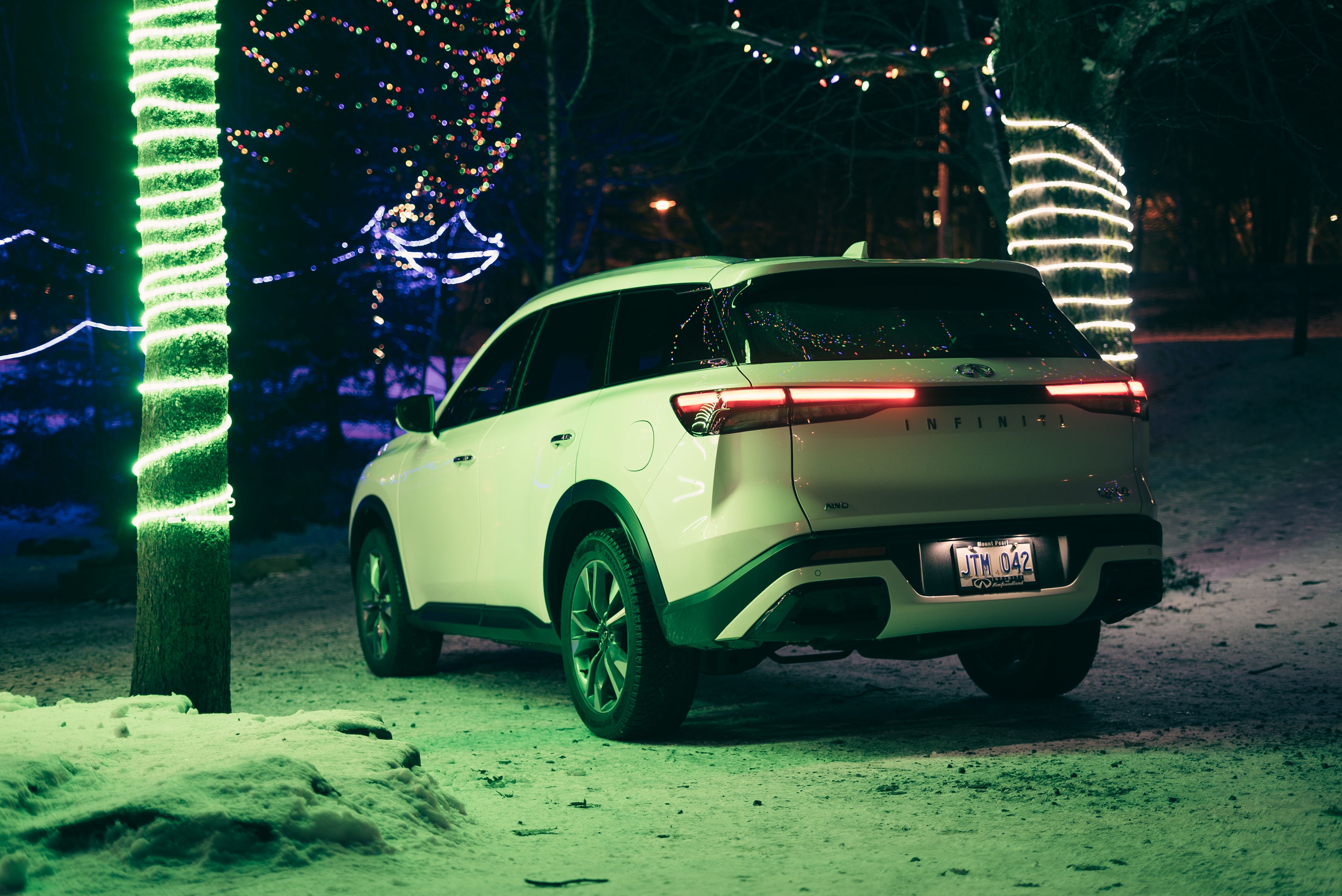 A SUV Illuminated by Christmas Lights · Free Stock Photo
