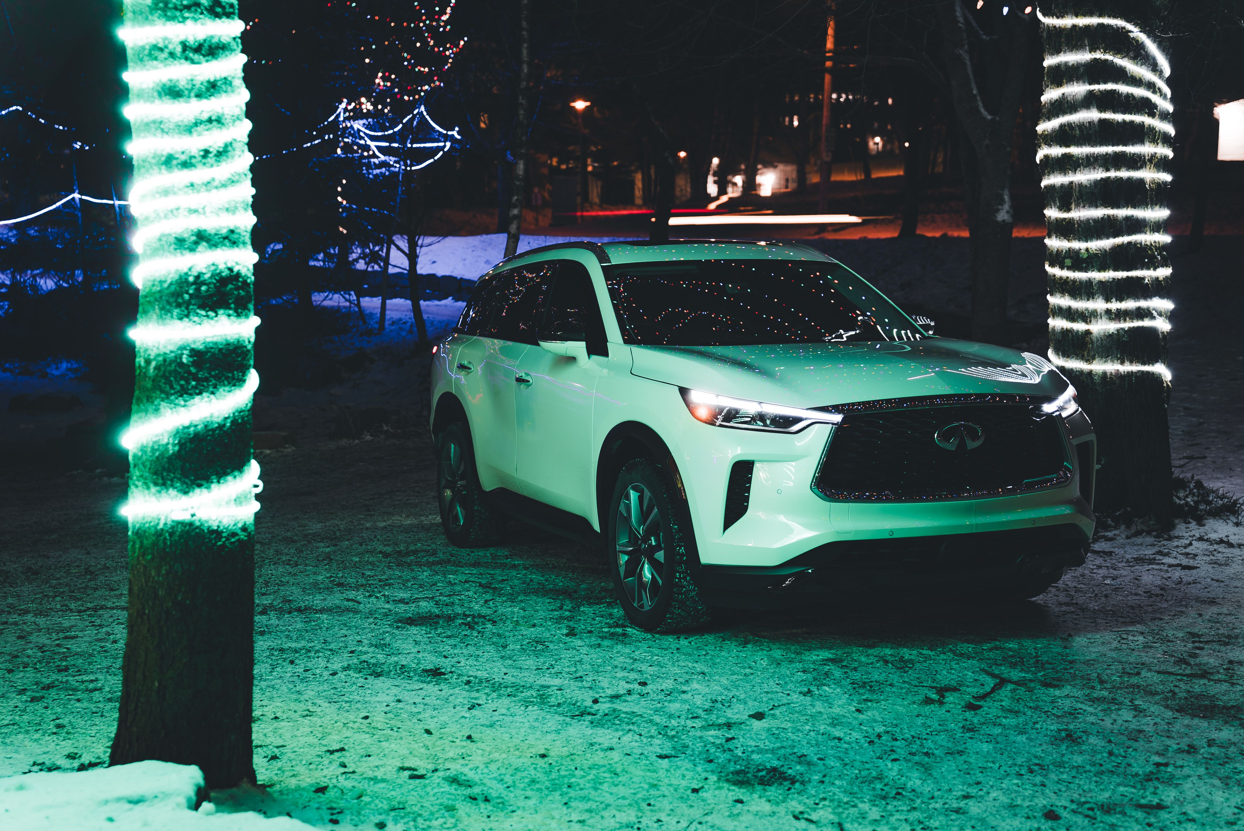 White 22 Infiniti QX60 Parked Between Illuminated Trees · Free Stock Photo