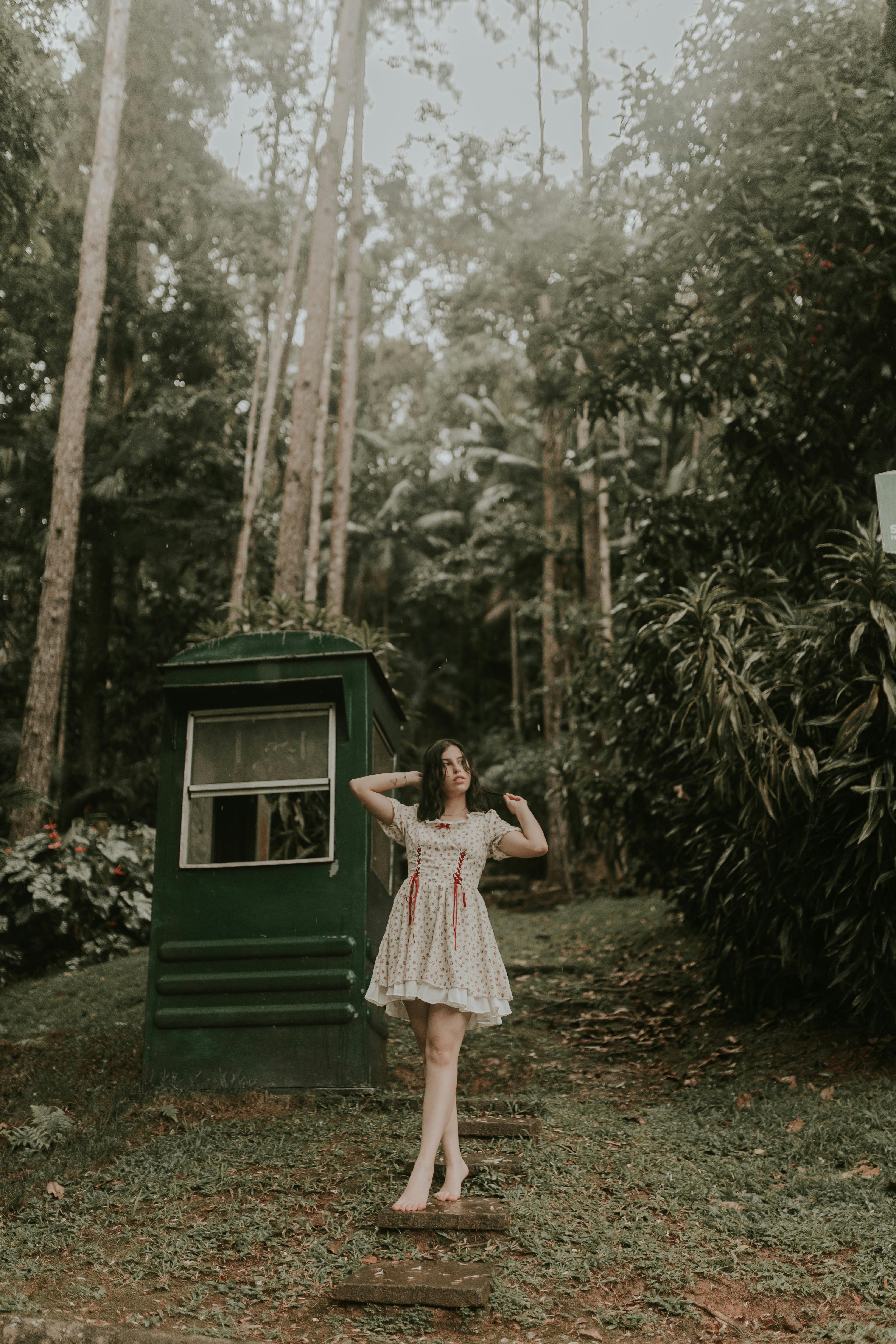 Female Model Standing Barefoot in front of a Forest Booth · Free Stock ...