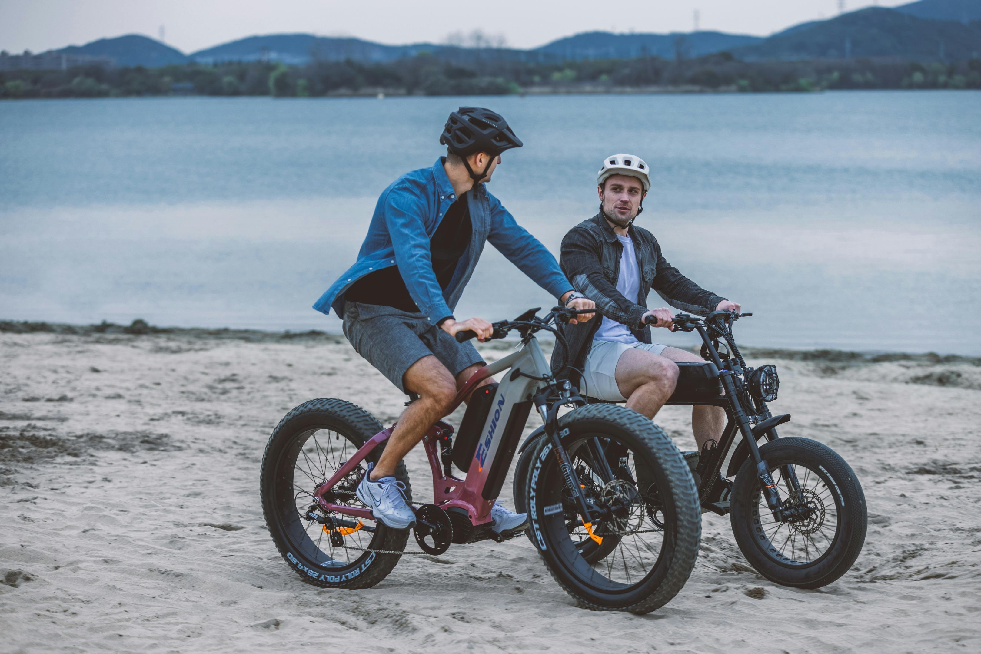Two Young Men Riding Electric Bikes along a Sandy Coastline · Free ...
