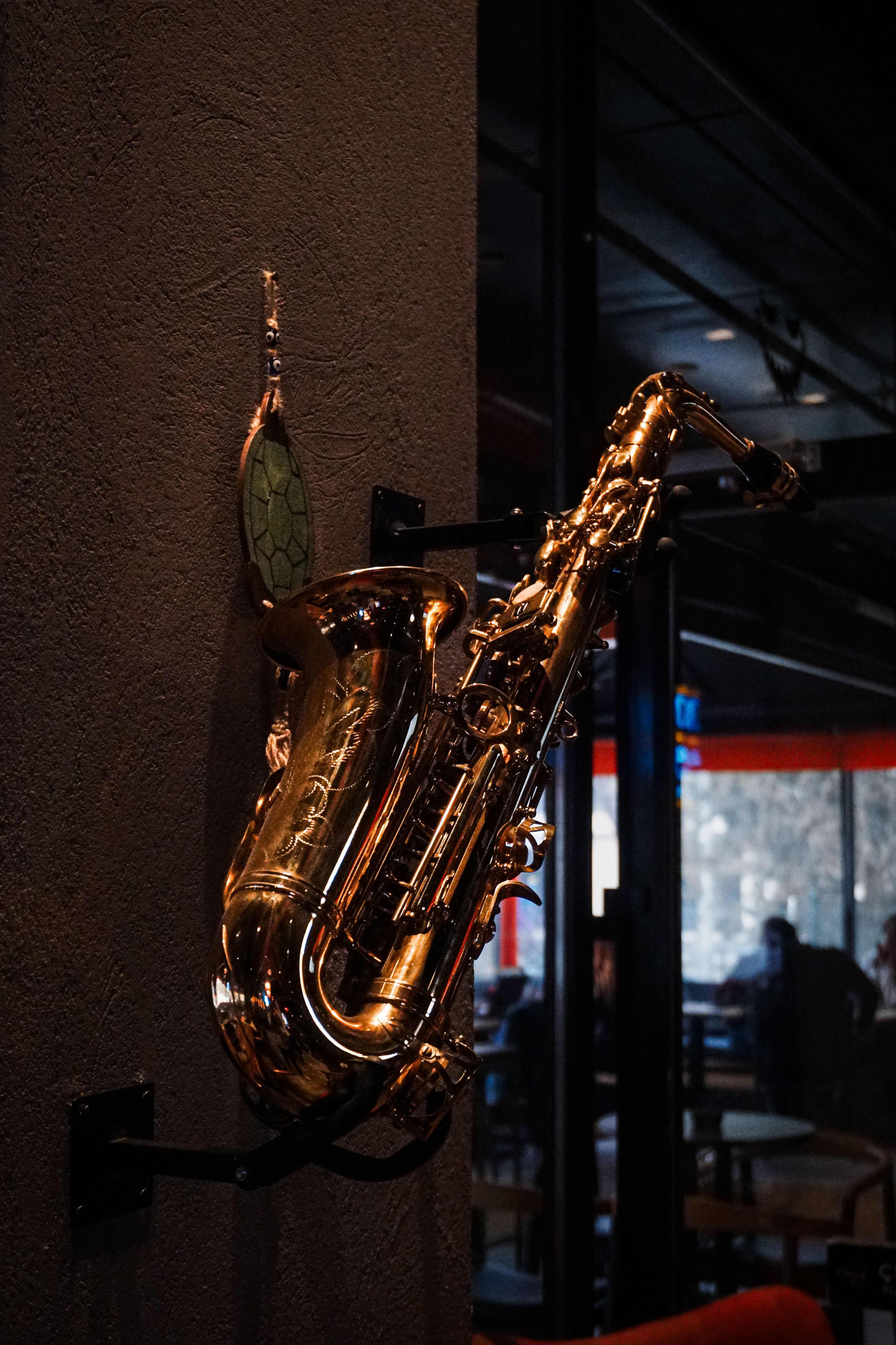 Close-up of a Saxophone Hanging on a Wall · Free Stock Photo