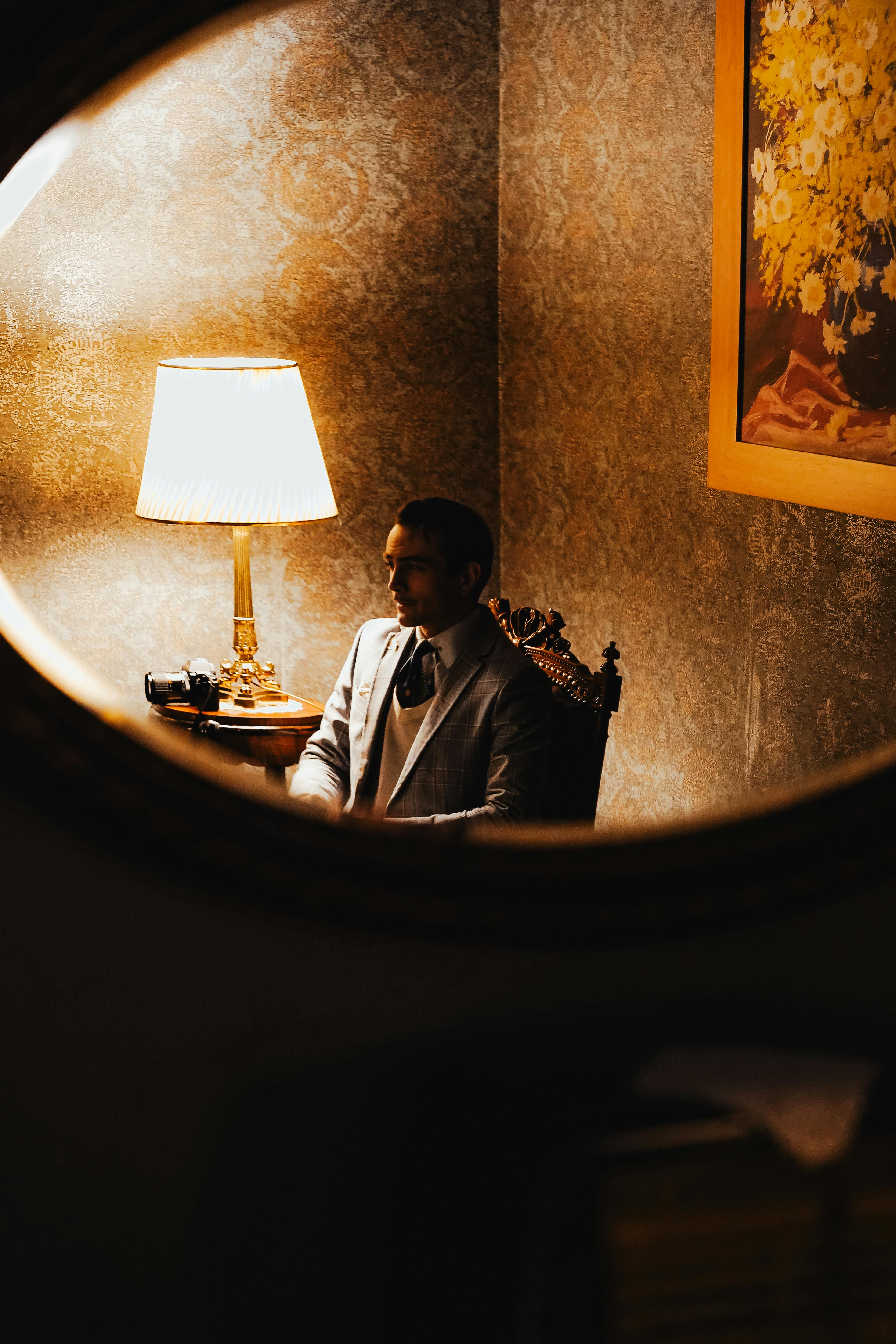 Elegant Man Sitting Next to a Lamp · Free Stock Photo