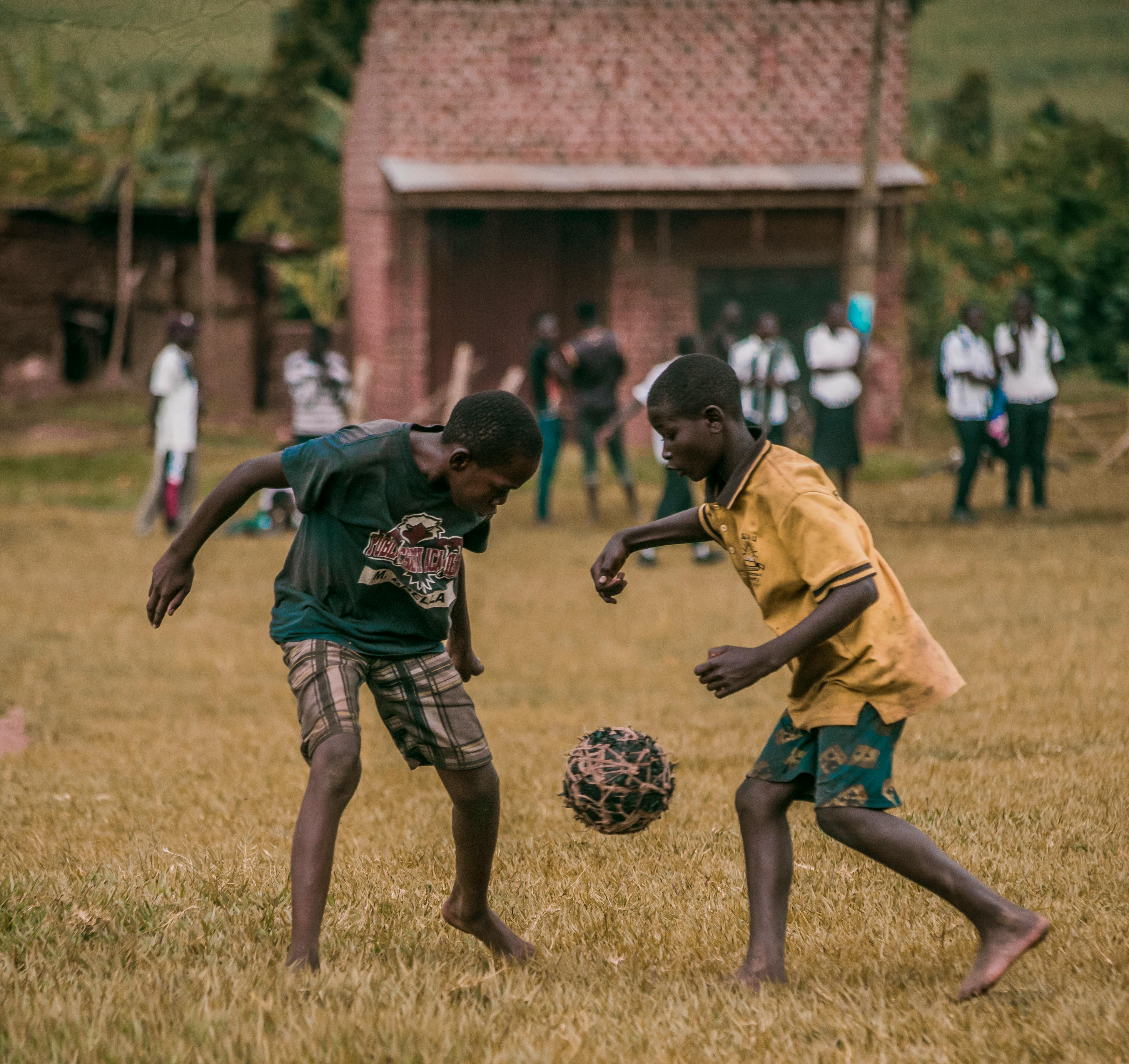 African Boys Playing Football on a Field · Free Stock Photo