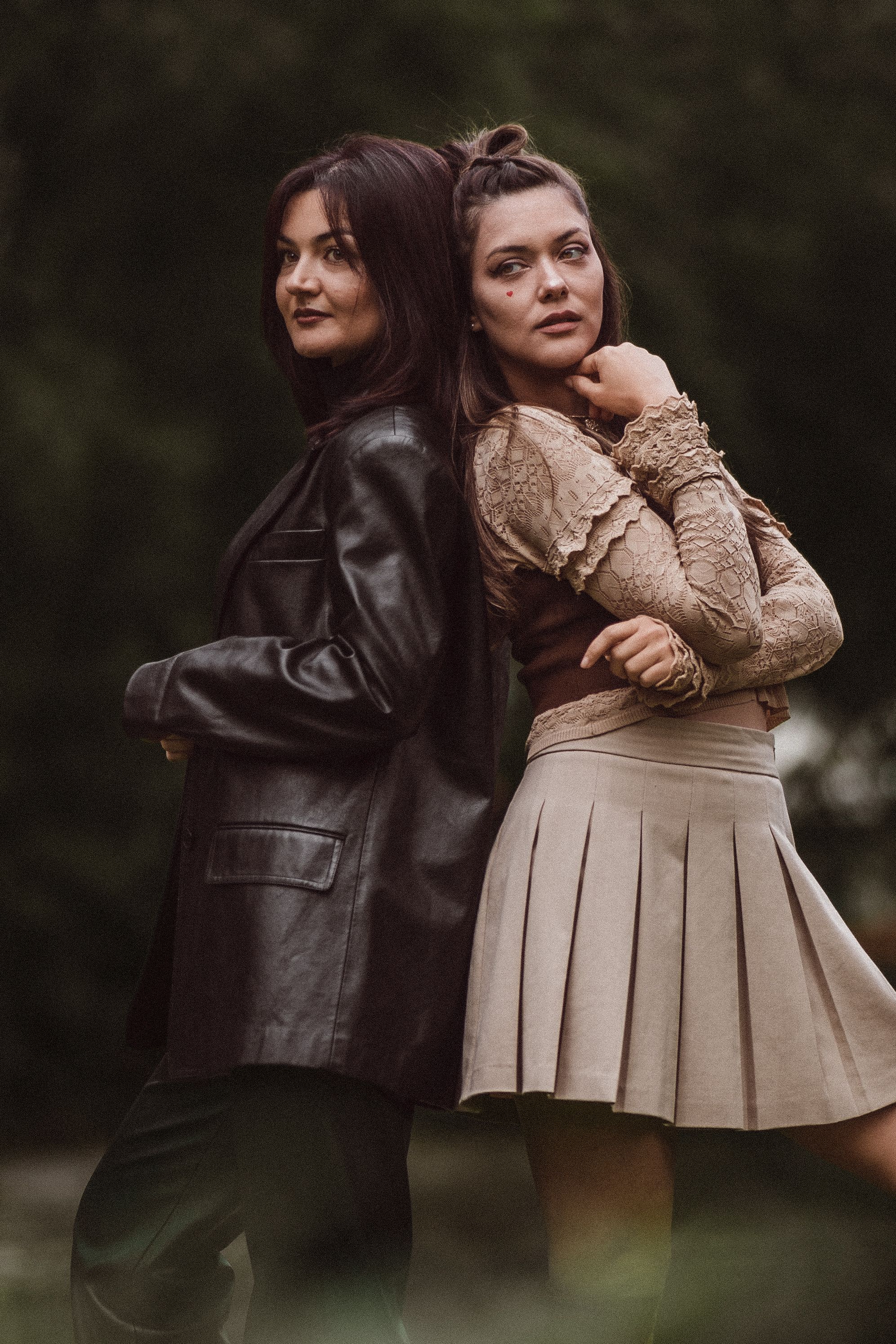 Two Fashionable Women Standing Outside Back to Back · Free Stock Photo