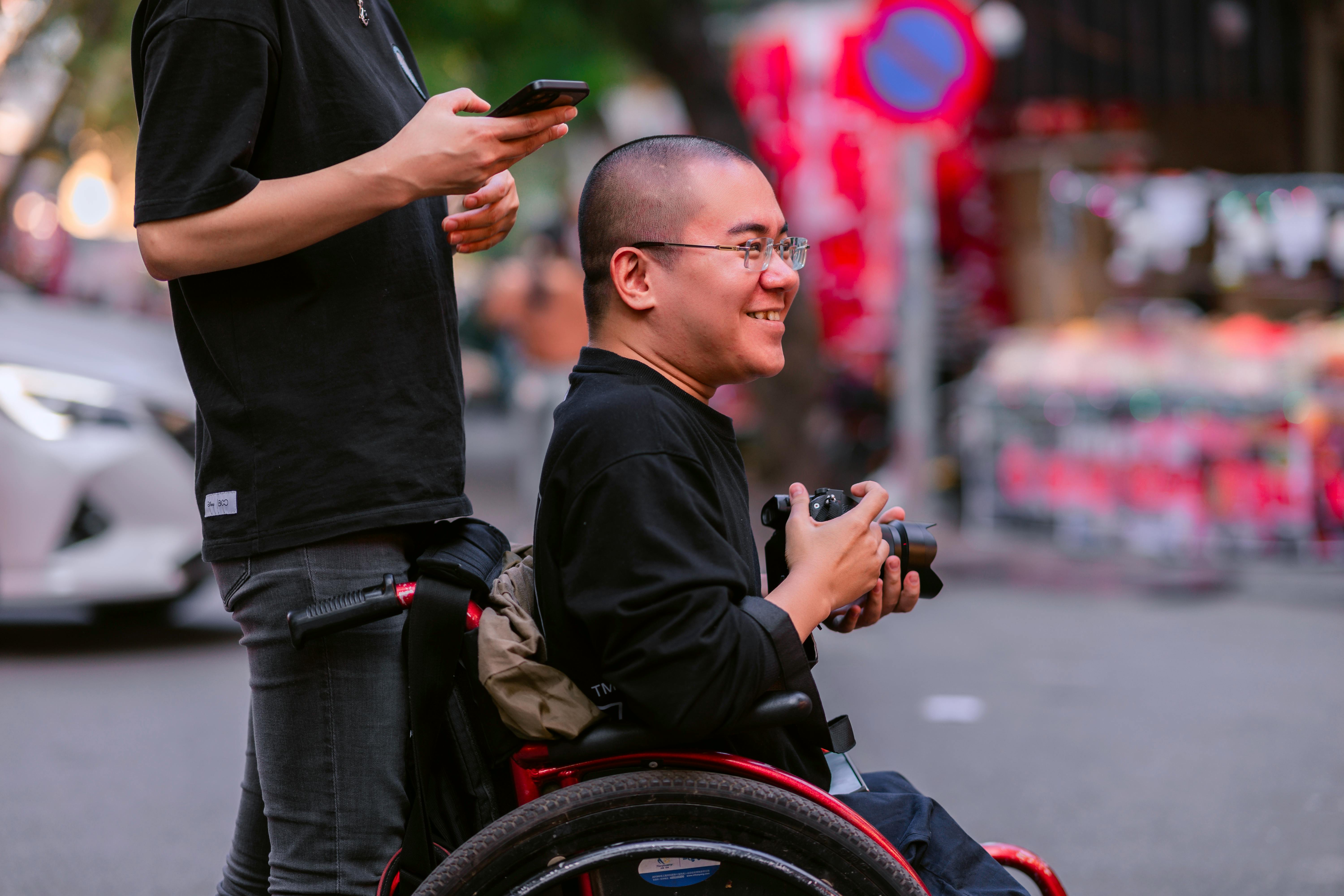 Closeup of a Photographer on a Wheelchair · Free Stock Photo