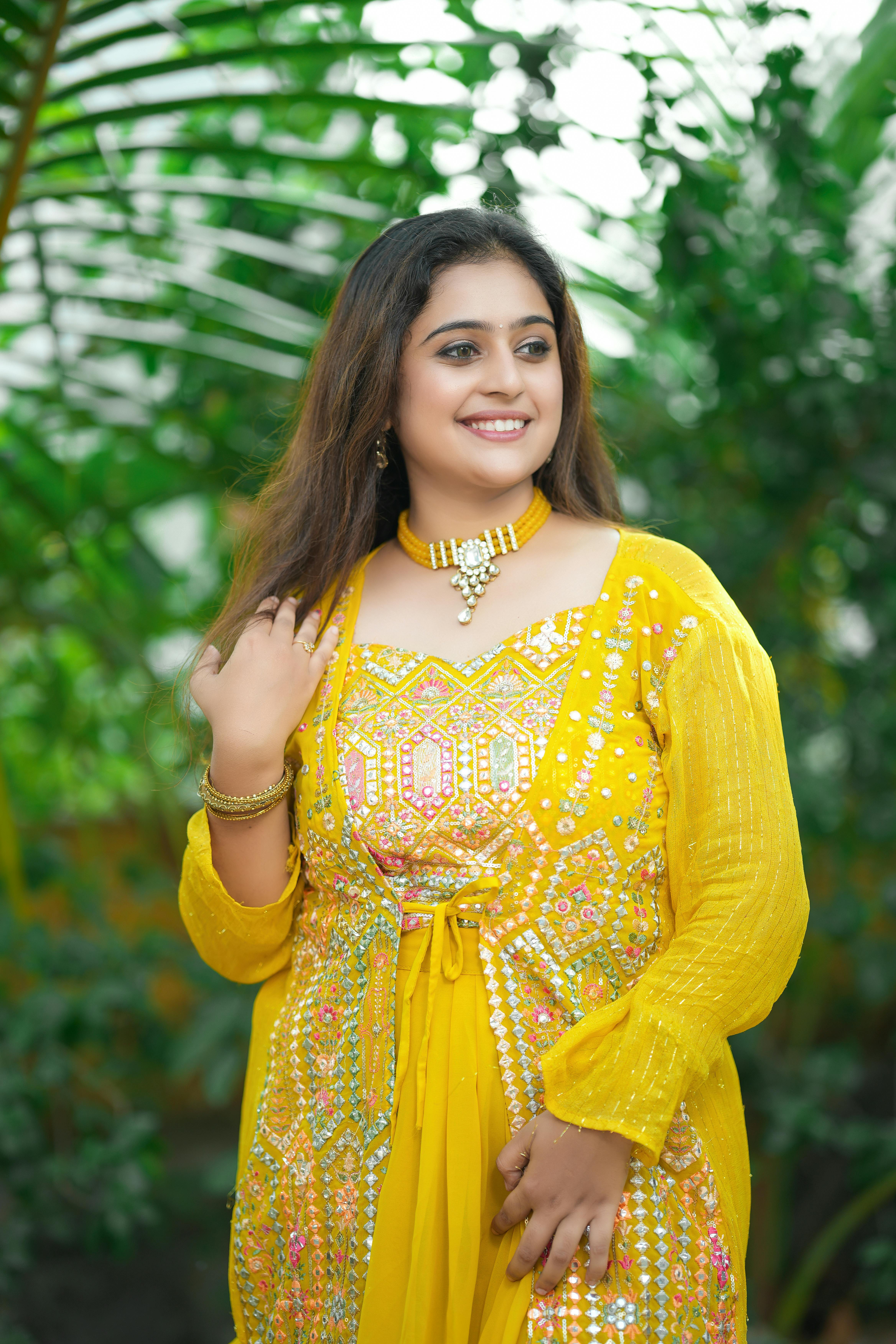 Woman in Dress Holding Big Leaves · Free Stock Photo