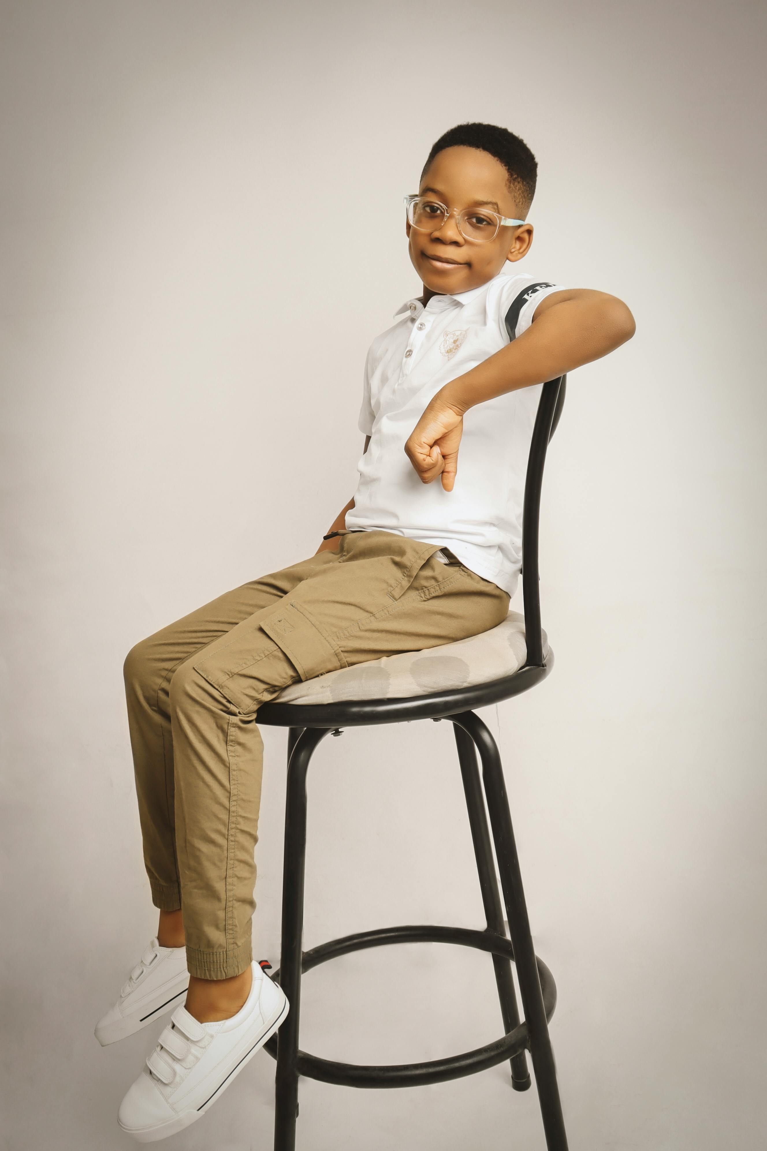 Child Model Posing on Stool · Free Stock Photo