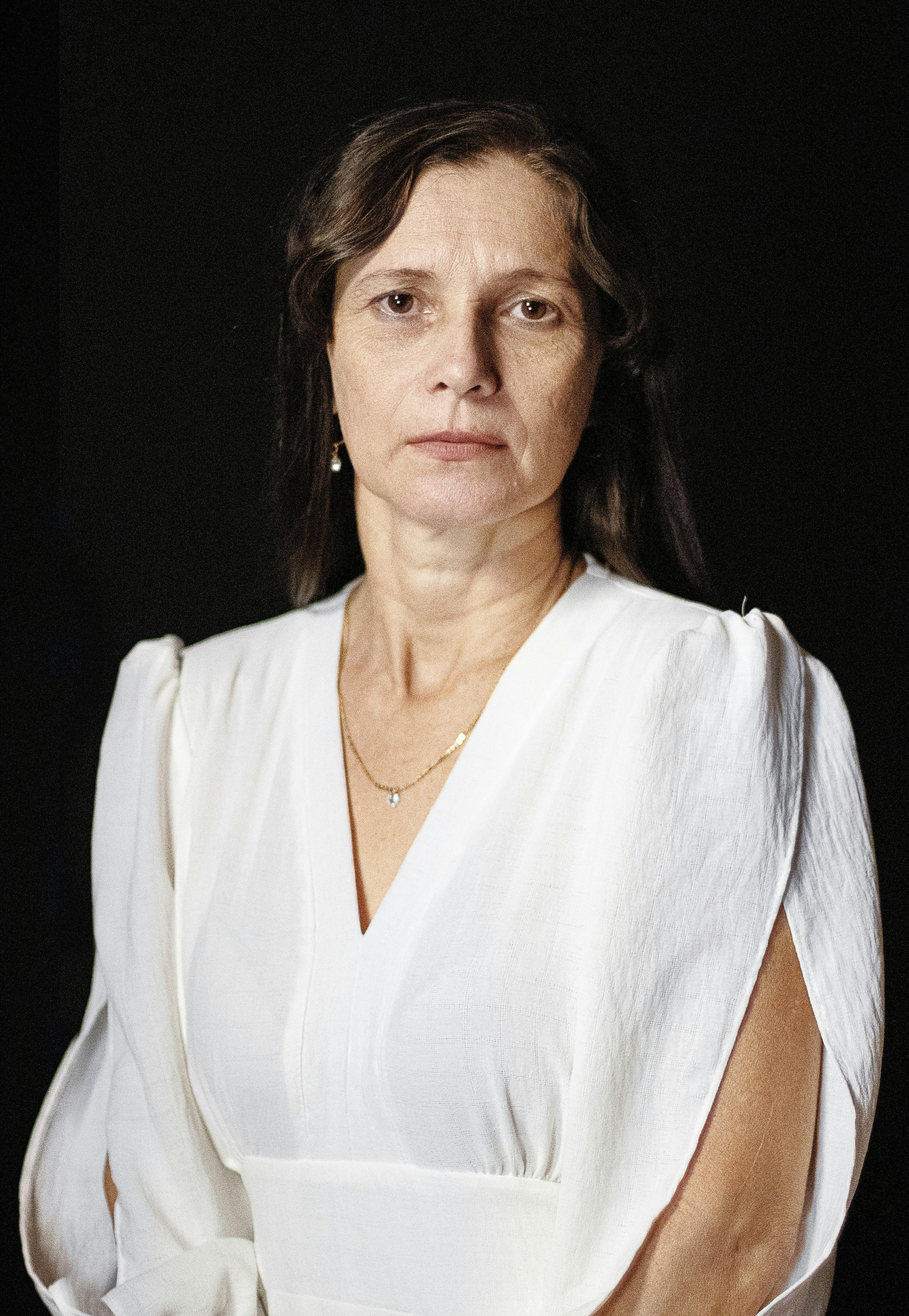 Portrait of a Serious Woman Wearing a White Blouse · Free Stock Photo