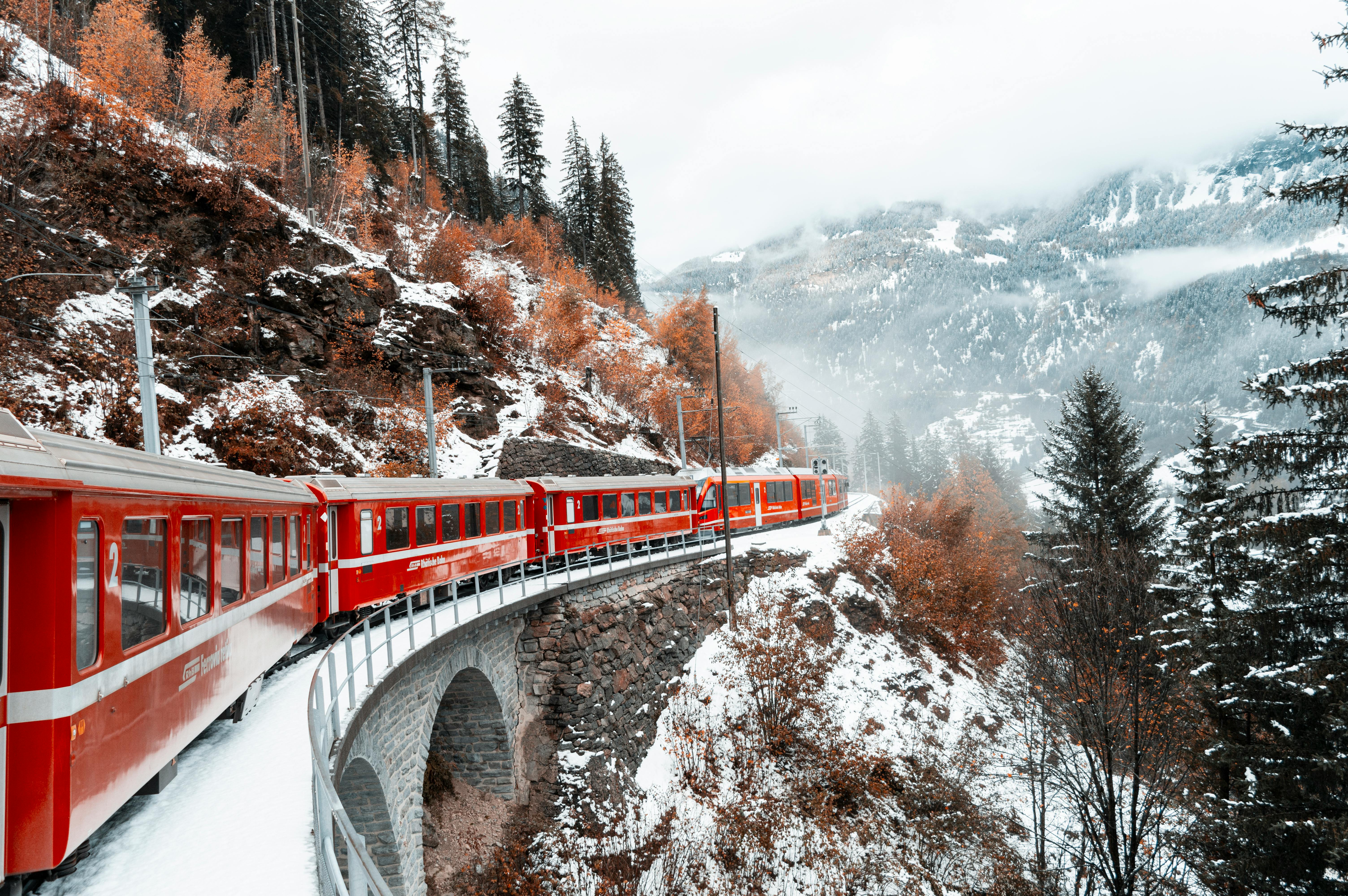 Red Train on Black Steel Train Rail during Day · Free Stock Photo