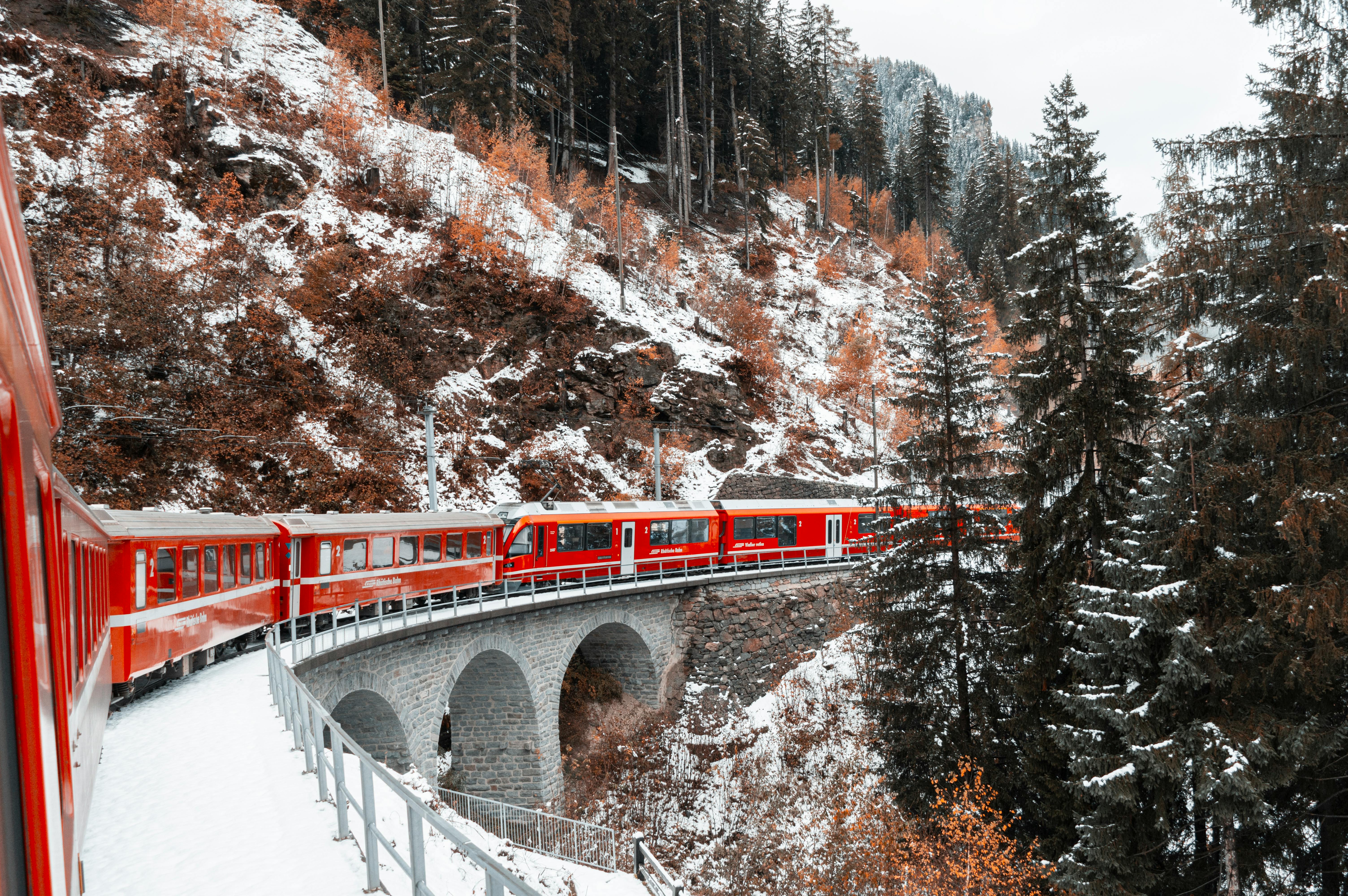 Red Train on Black Steel Train Rail during Day · Free Stock Photo