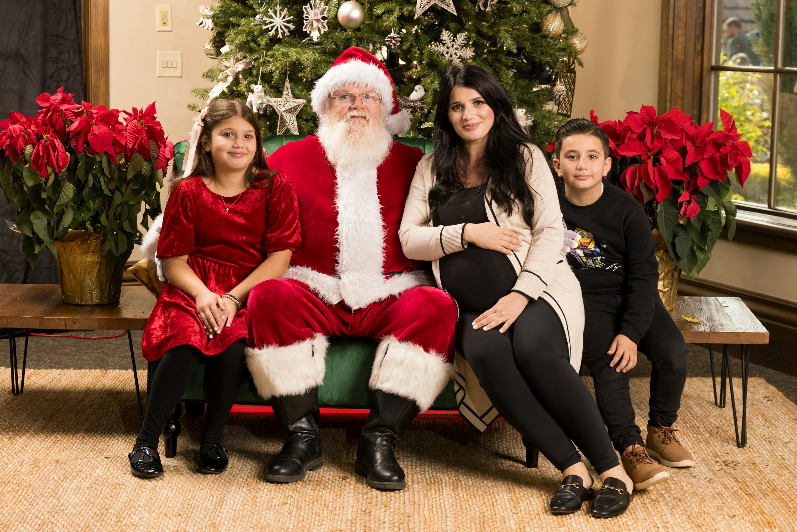 A family poses for a photo with santa claus · Free Stock Photo