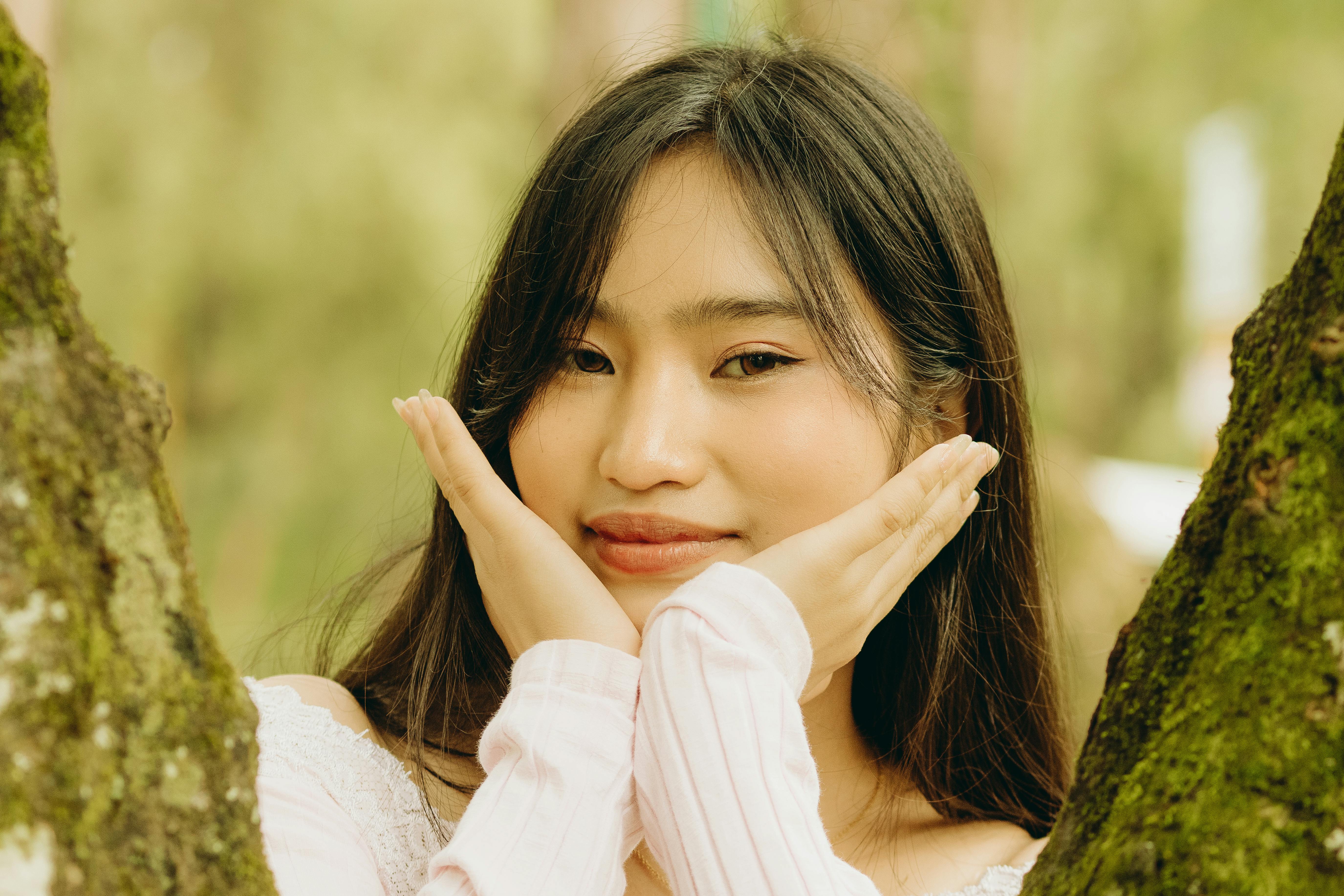 Woman Face Between Two Tree Trunks · Free Stock Photo