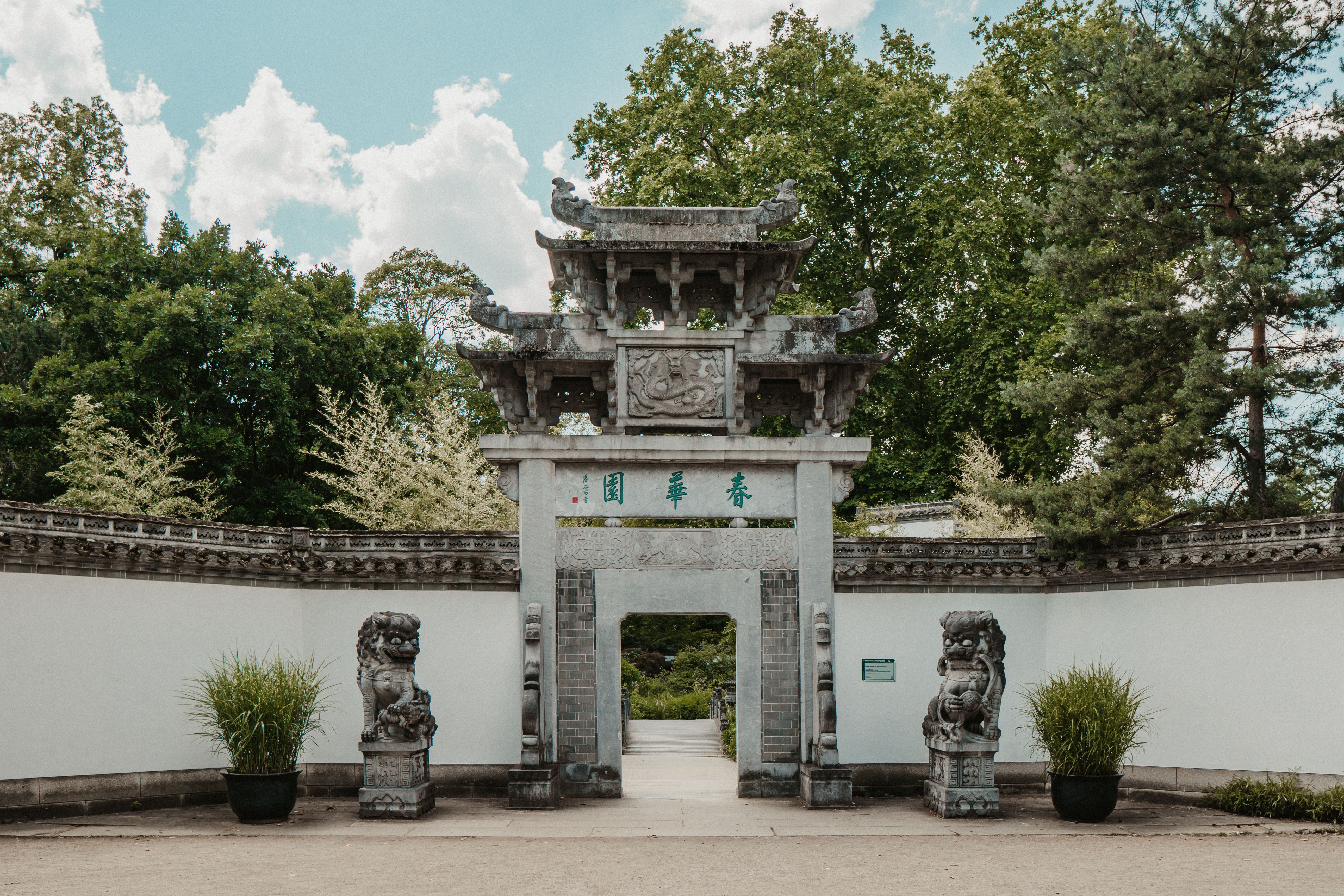 A gate with two statues in front of it · Free Stock Photo