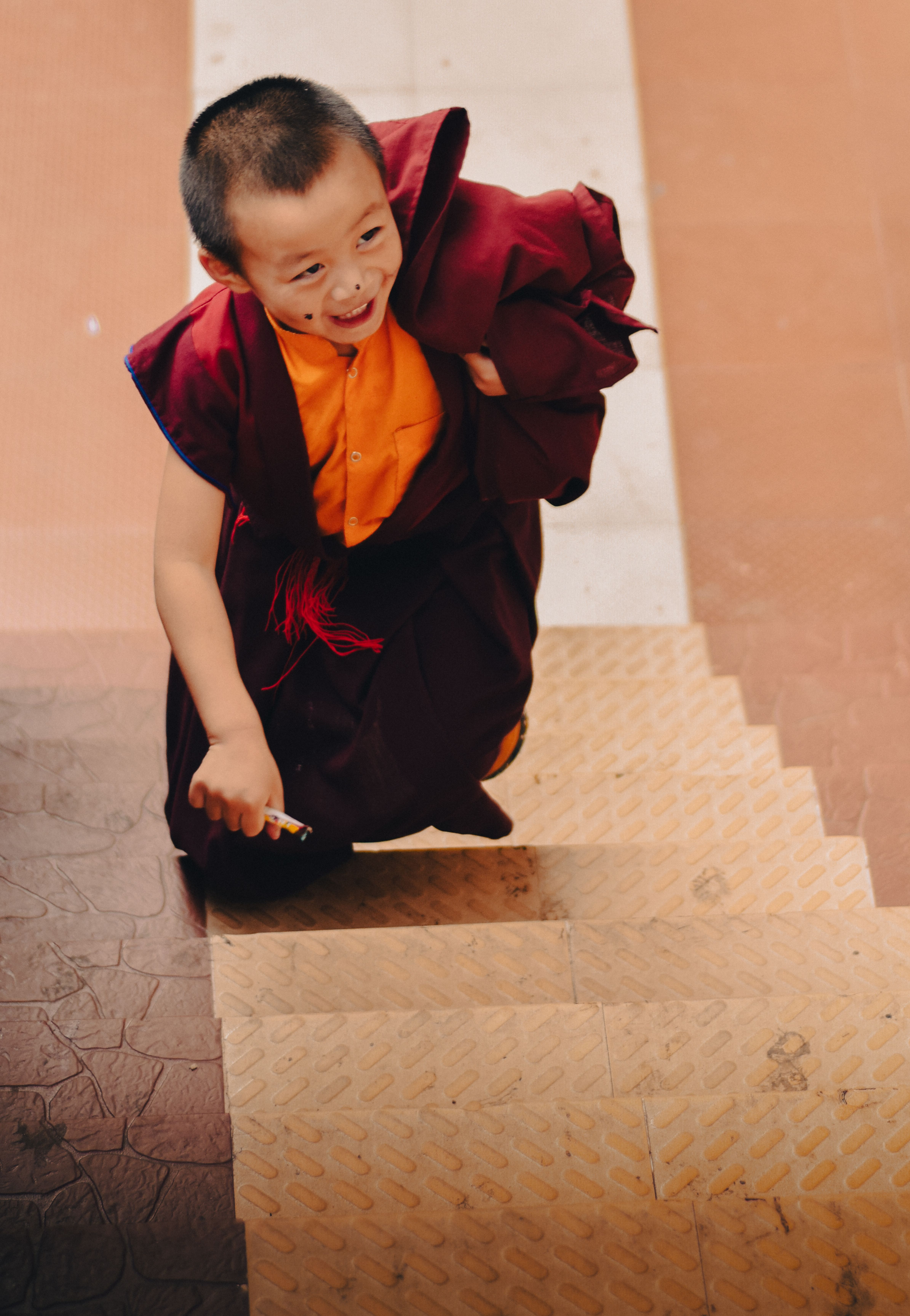 Smiling Boy in Buddhist Monk Robes · Free Stock Photo