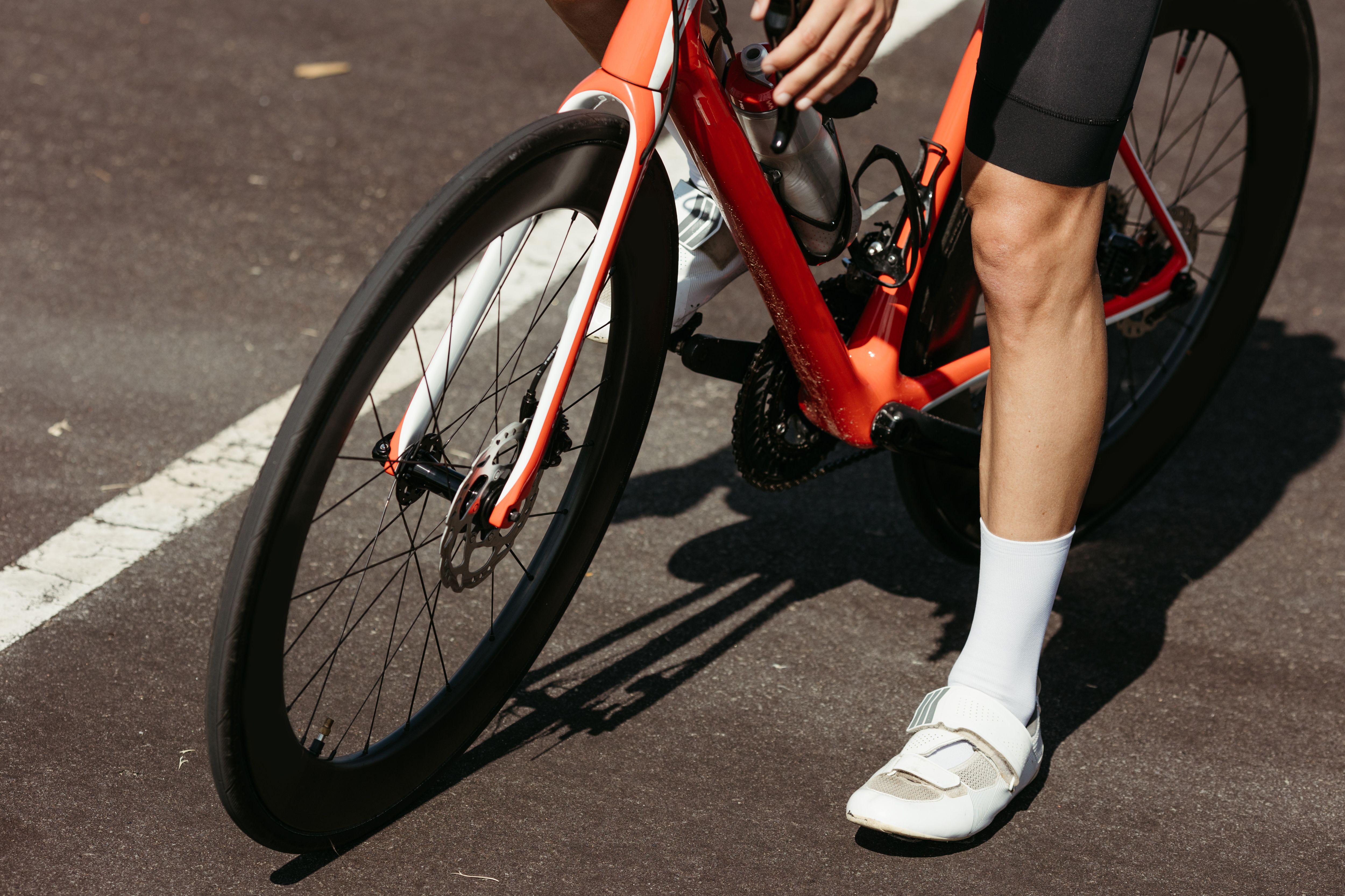 A person riding a bike on the road · Free Stock Photo