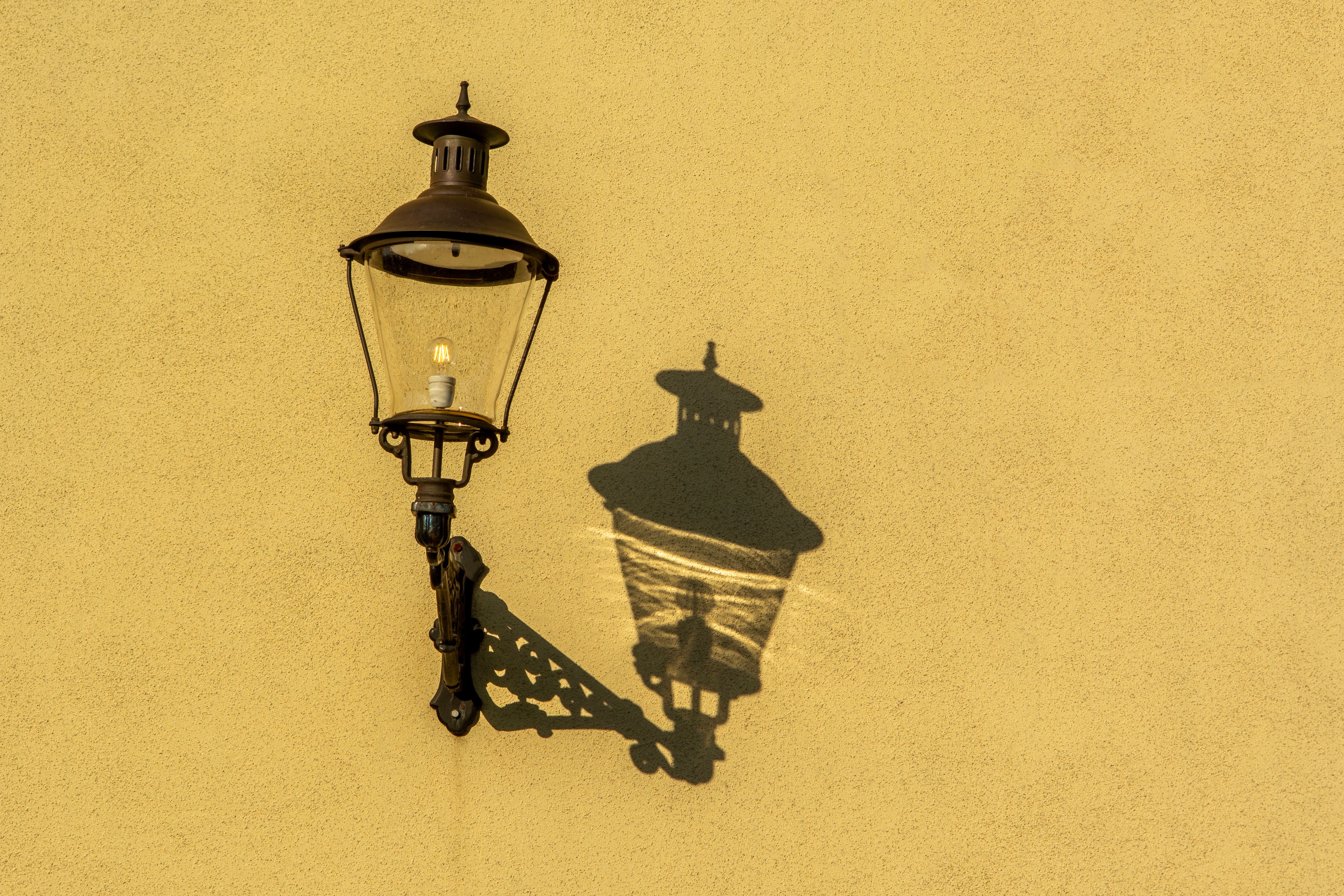 Old-Fashioned Street Light Casting Shadow on a Yellow Wall · Free Stock ...