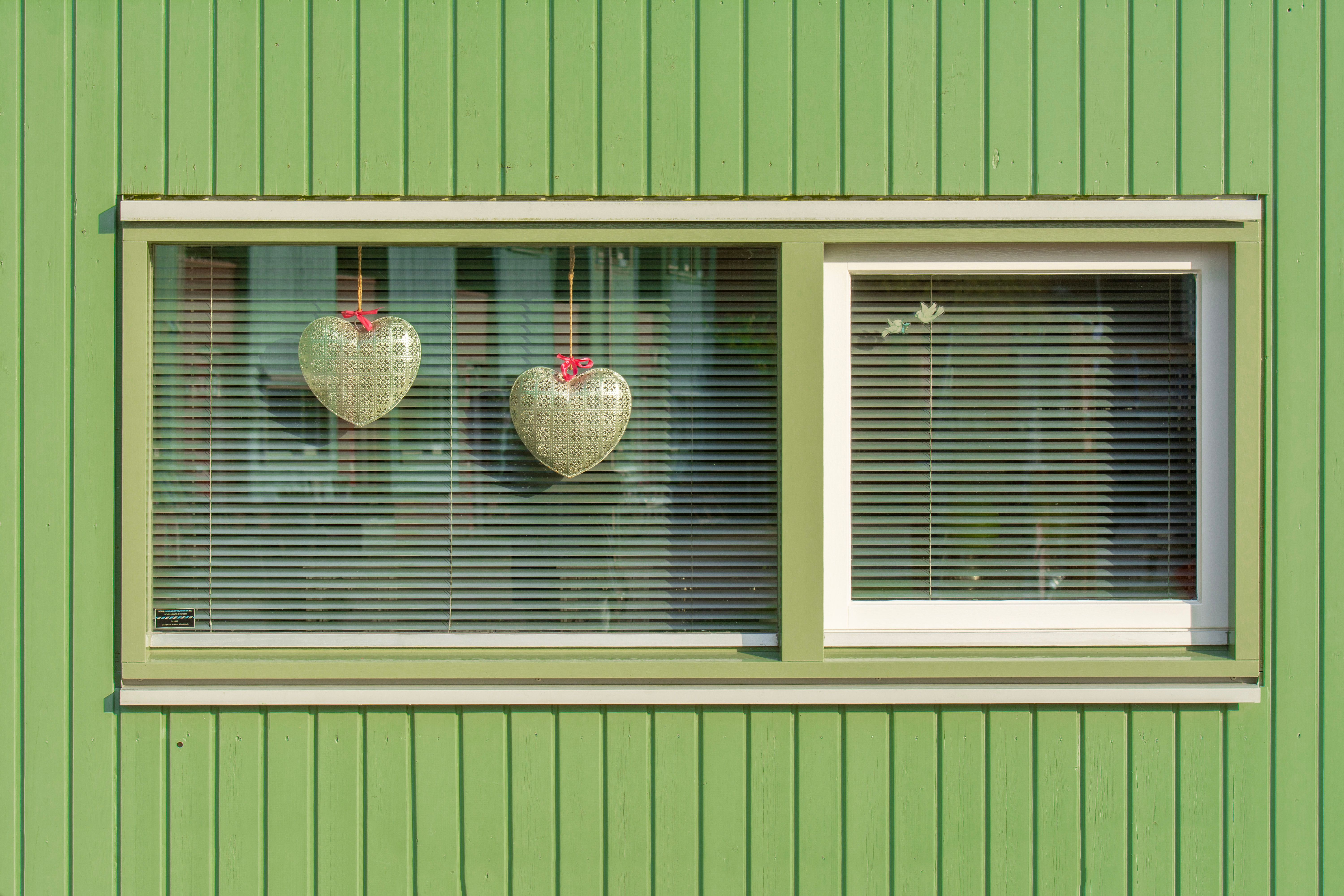 Heart Shaped Decorations Hanging behind a Window · Free Stock Photo