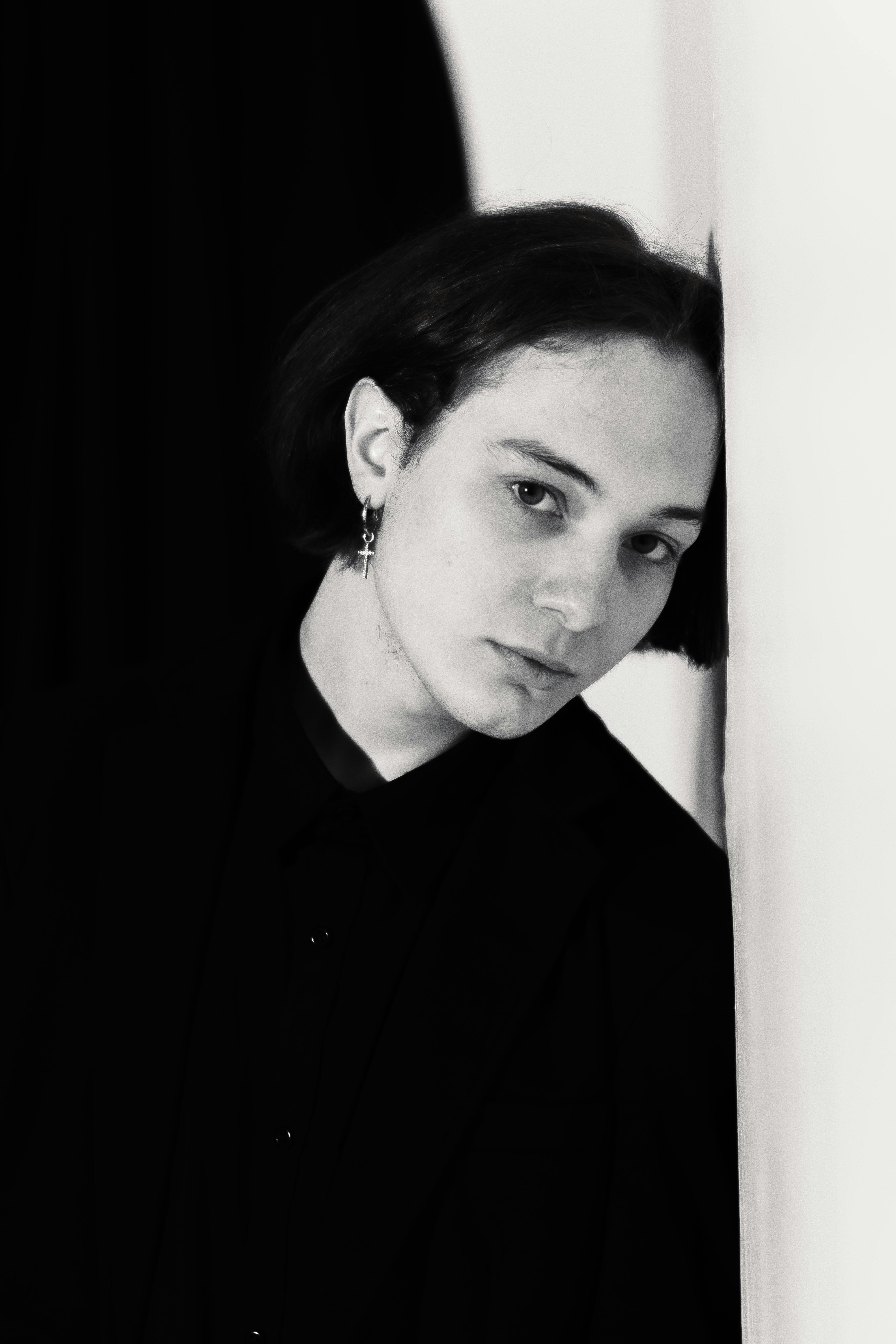 Black and White Photo of a Young Person Standing by the Wall · Free ...