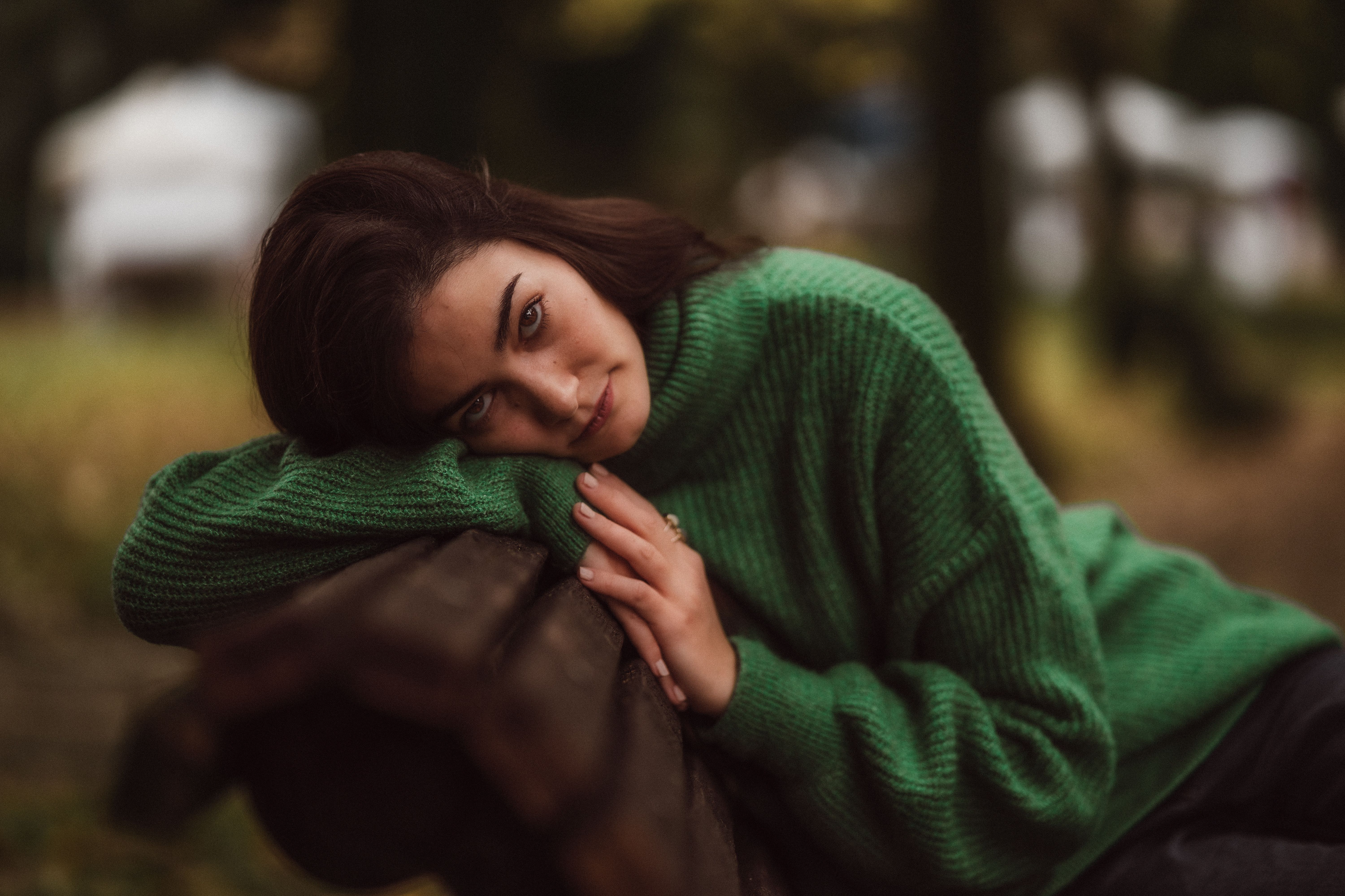 Young Woman in a Green Sweater Sitting on a Bench in a Park · Free ...