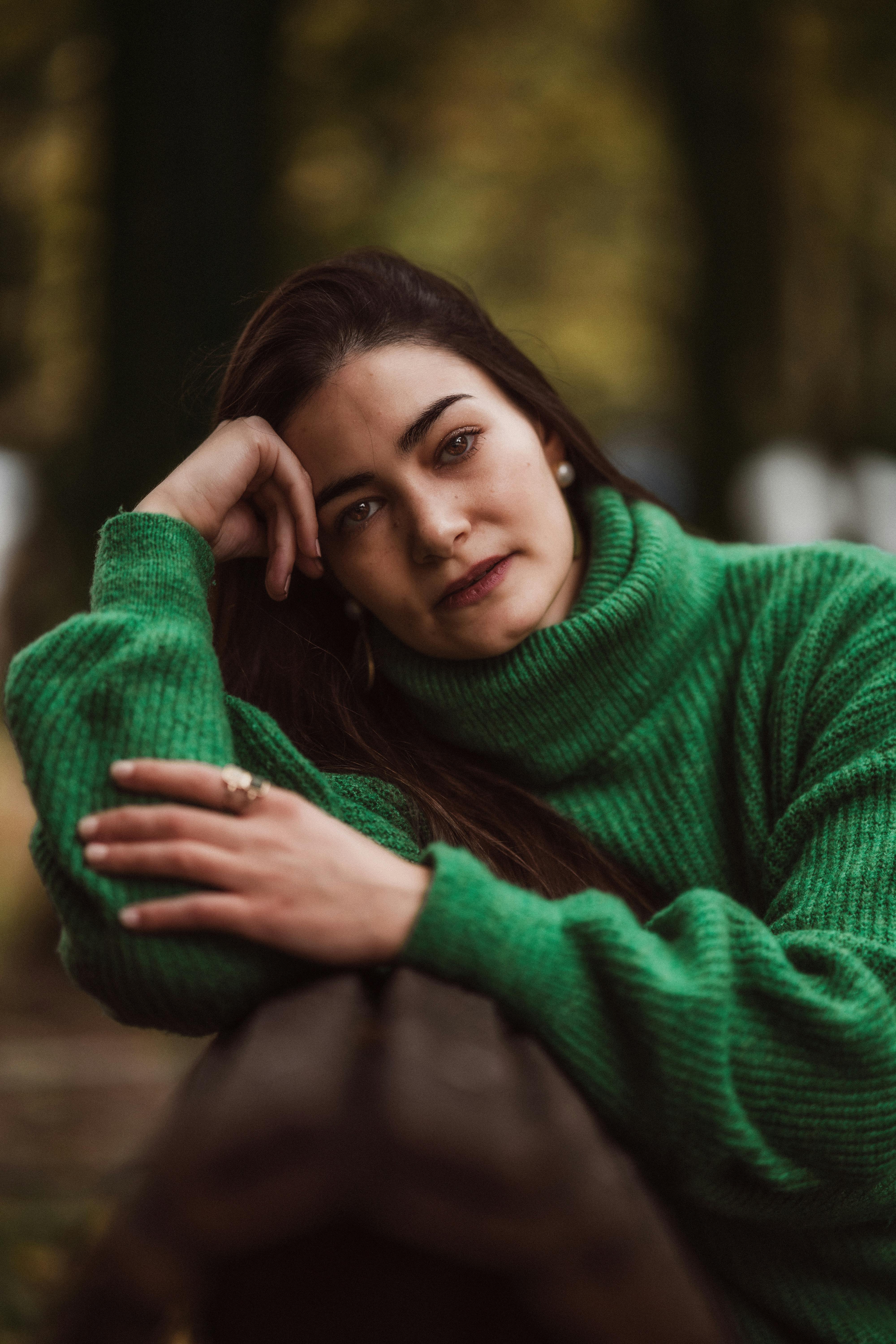 Young Woman in a Green Sweater Sitting on a Bench in a Park · Free ...