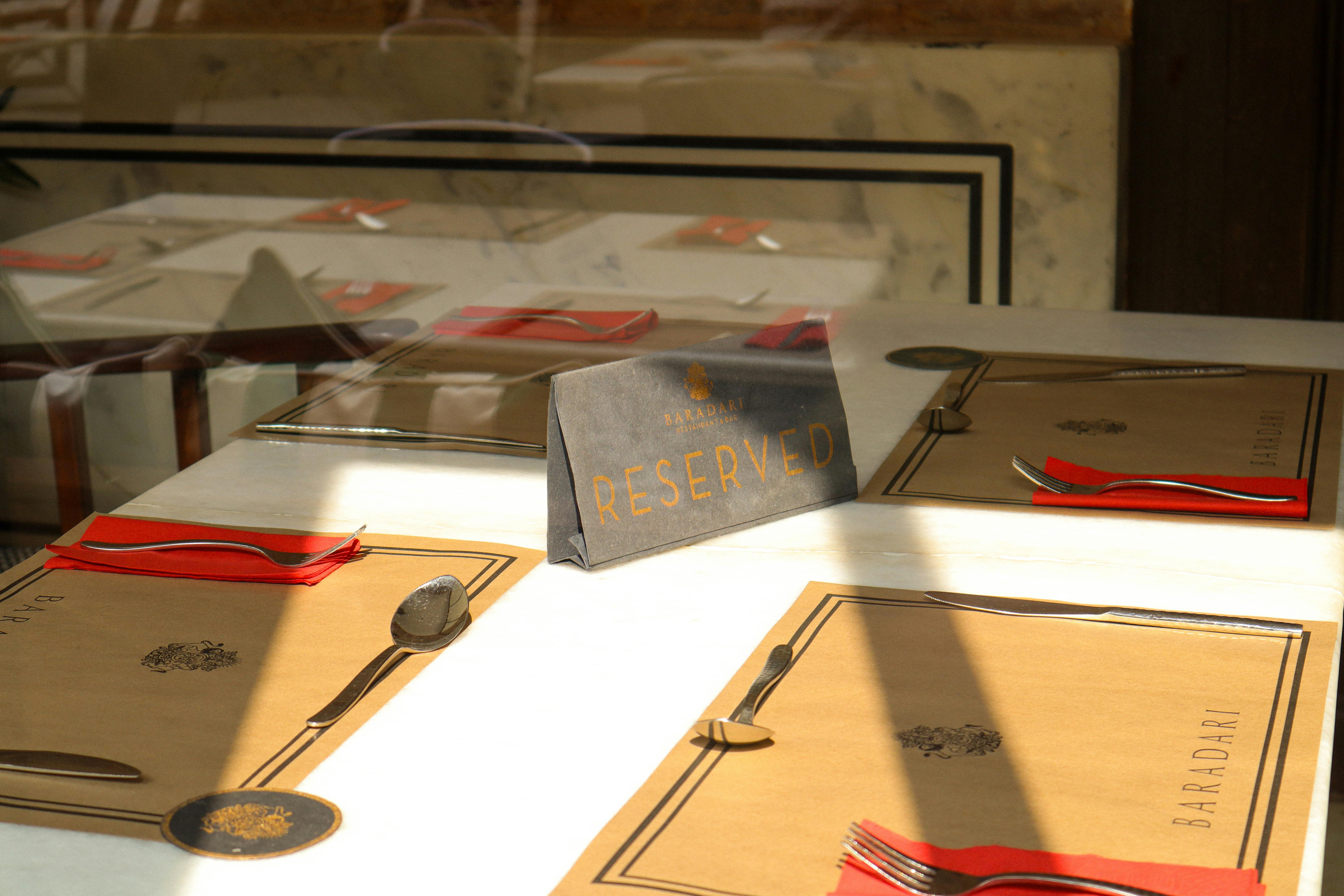 Table in a Restaurant with a Reserved Sign · Free Stock Photo