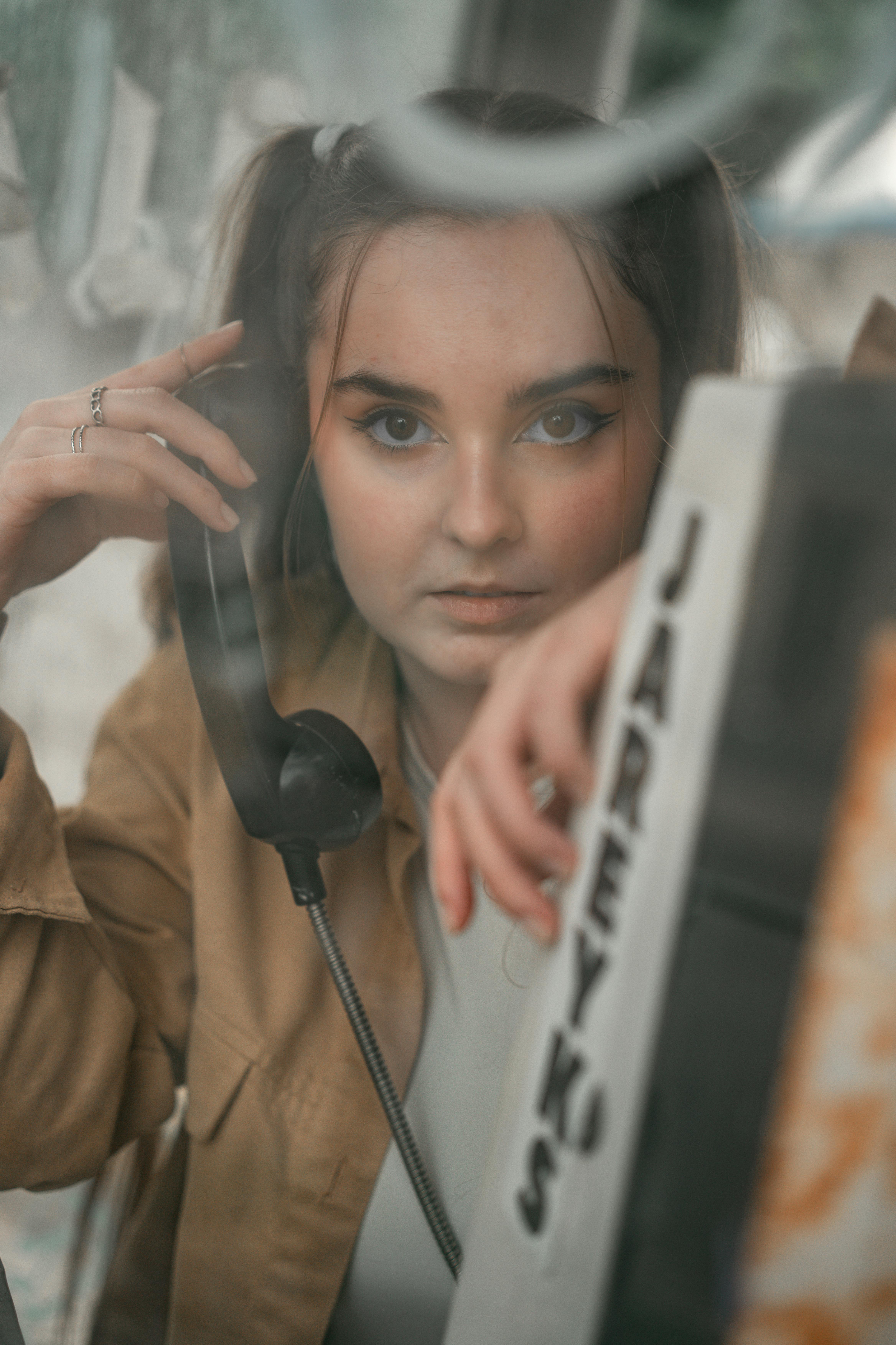 Photo of a Woman in a Phone Box · Free Stock Photo
