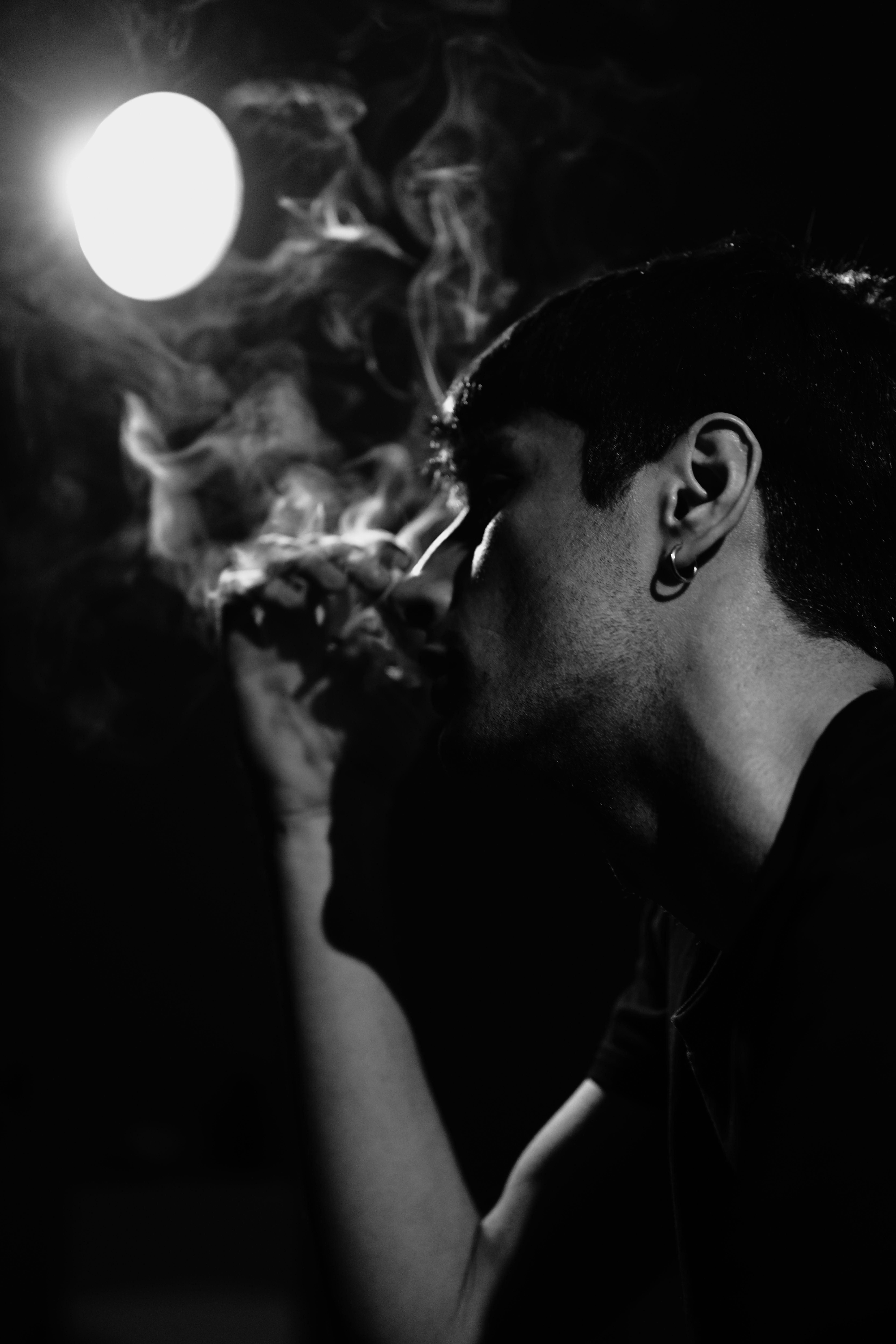 Man Leaning on the Wall while Smoking · Free Stock Photo
